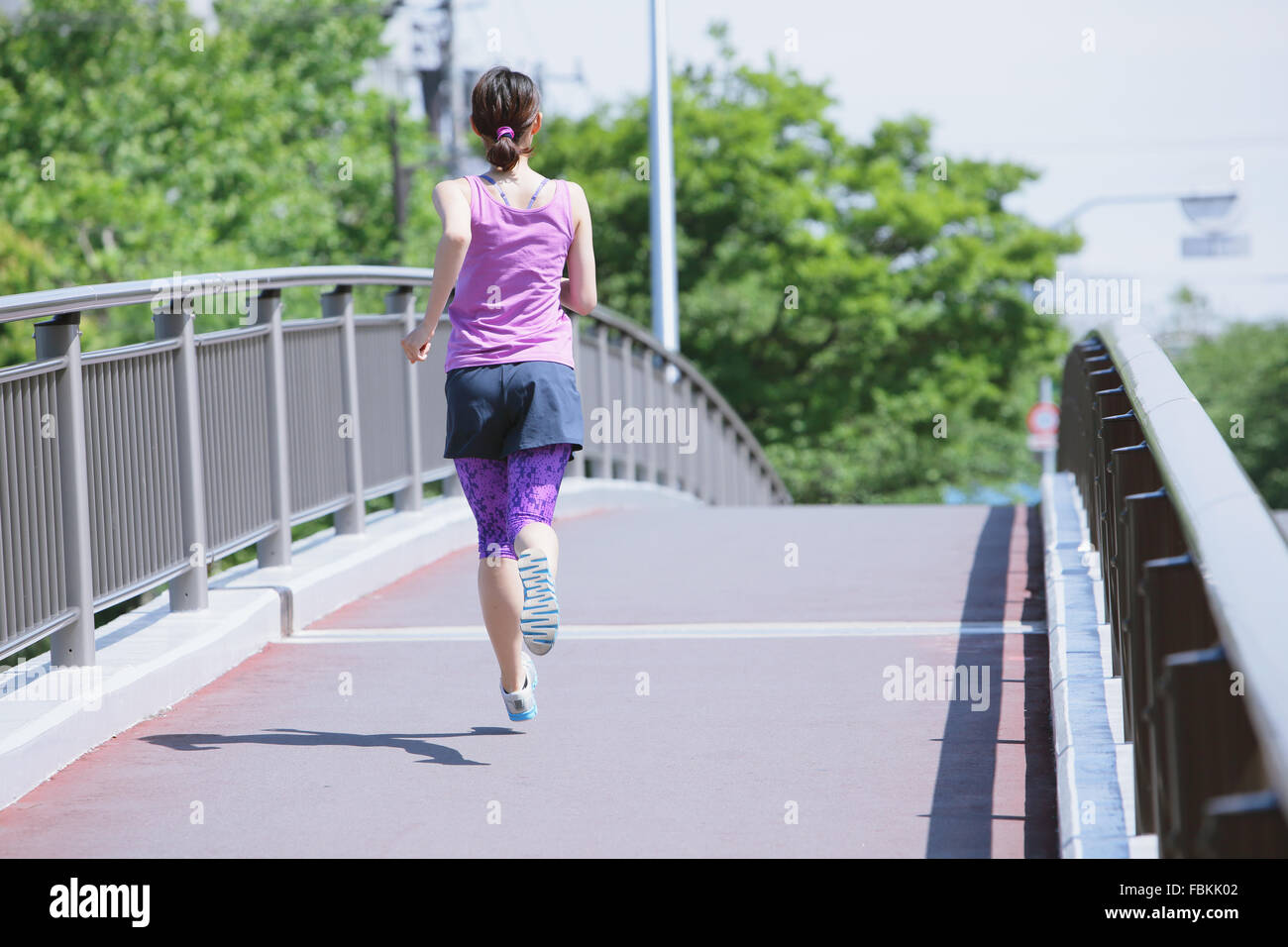 Young Japanese woman running downtown Tokyo Stock Photo - Alamy