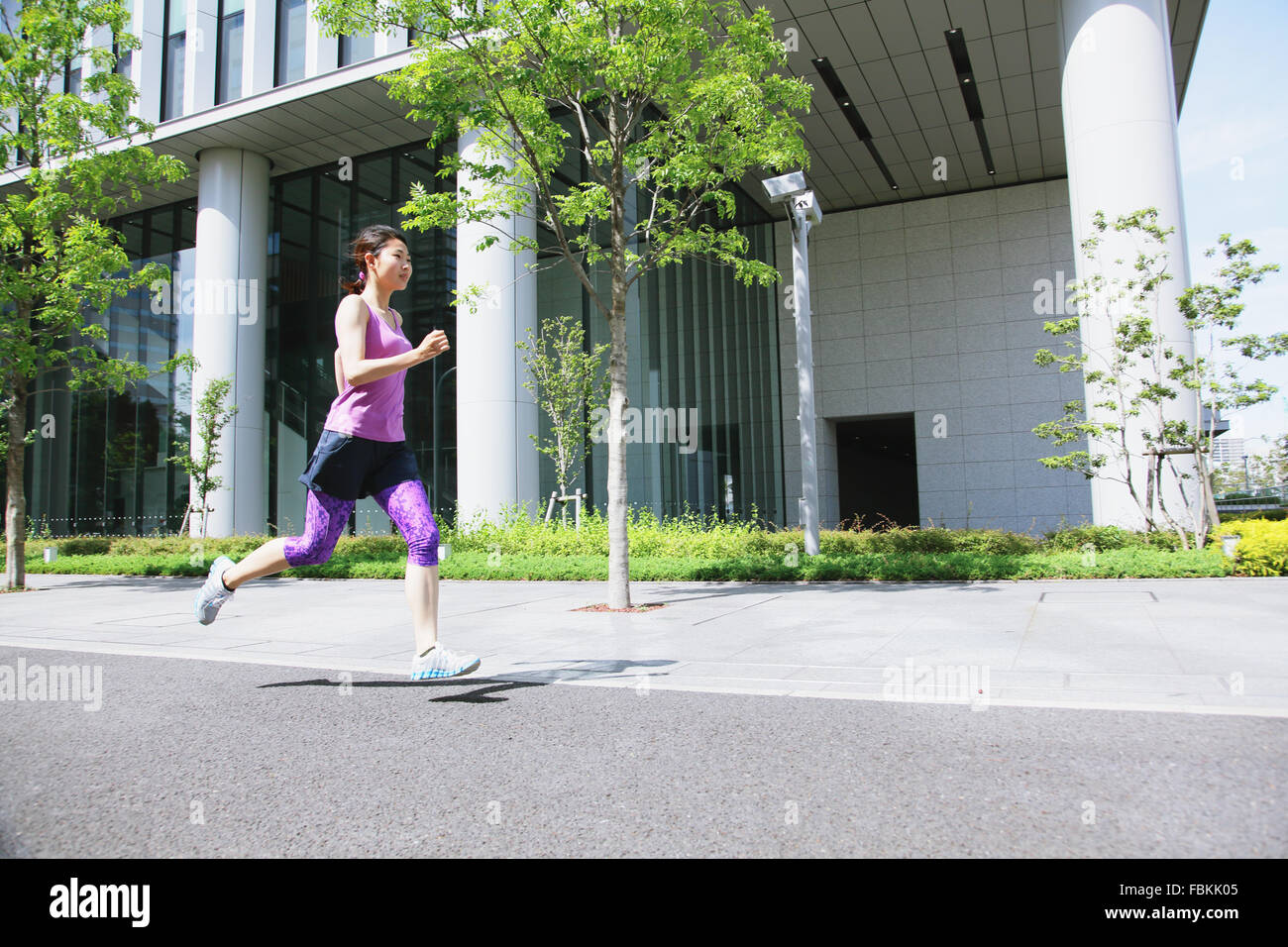 Young Japanese woman running downtown Tokyo Stock Photo - Alamy