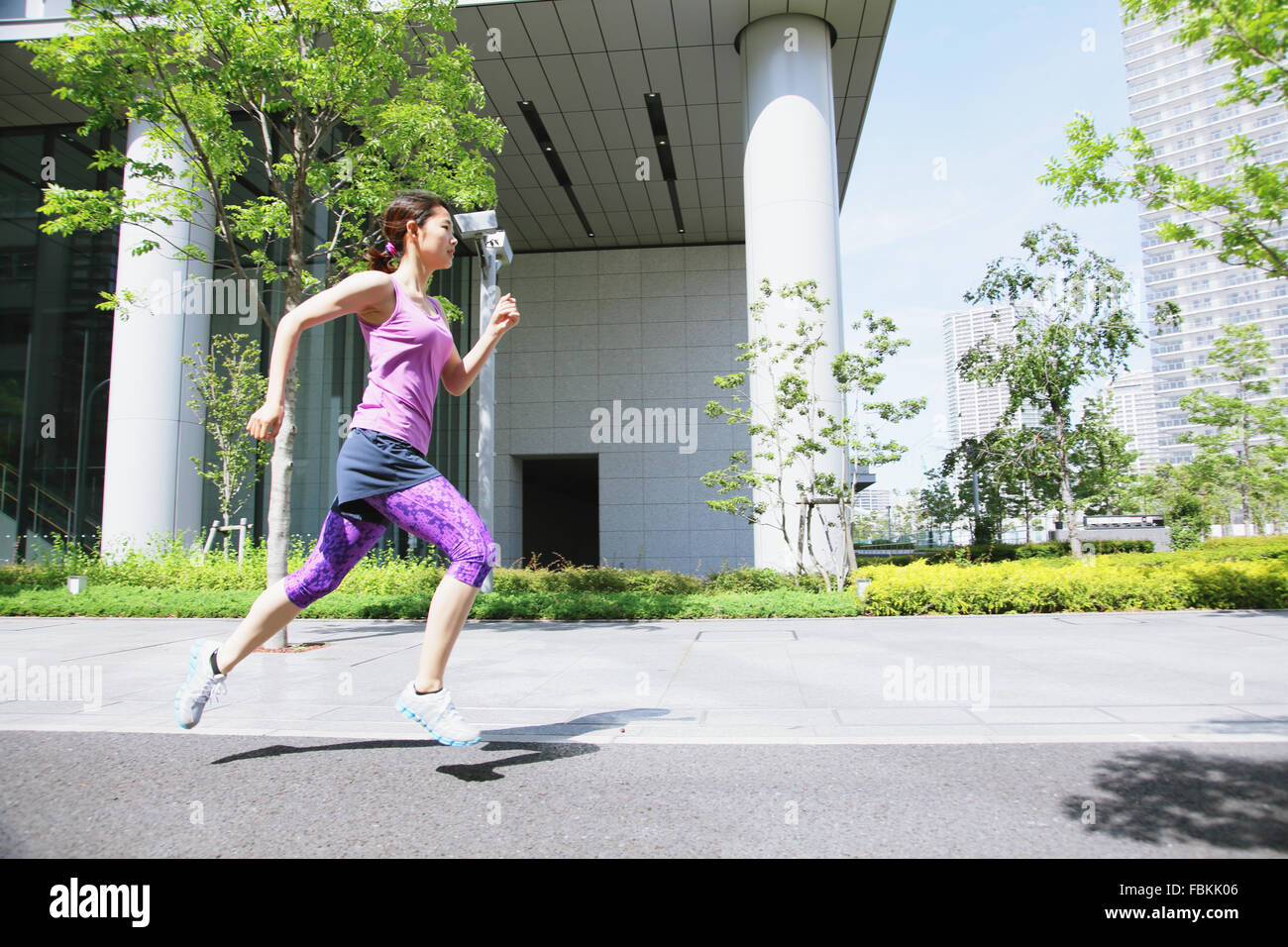 Young Japanese woman running downtown Tokyo Stock Photo - Alamy