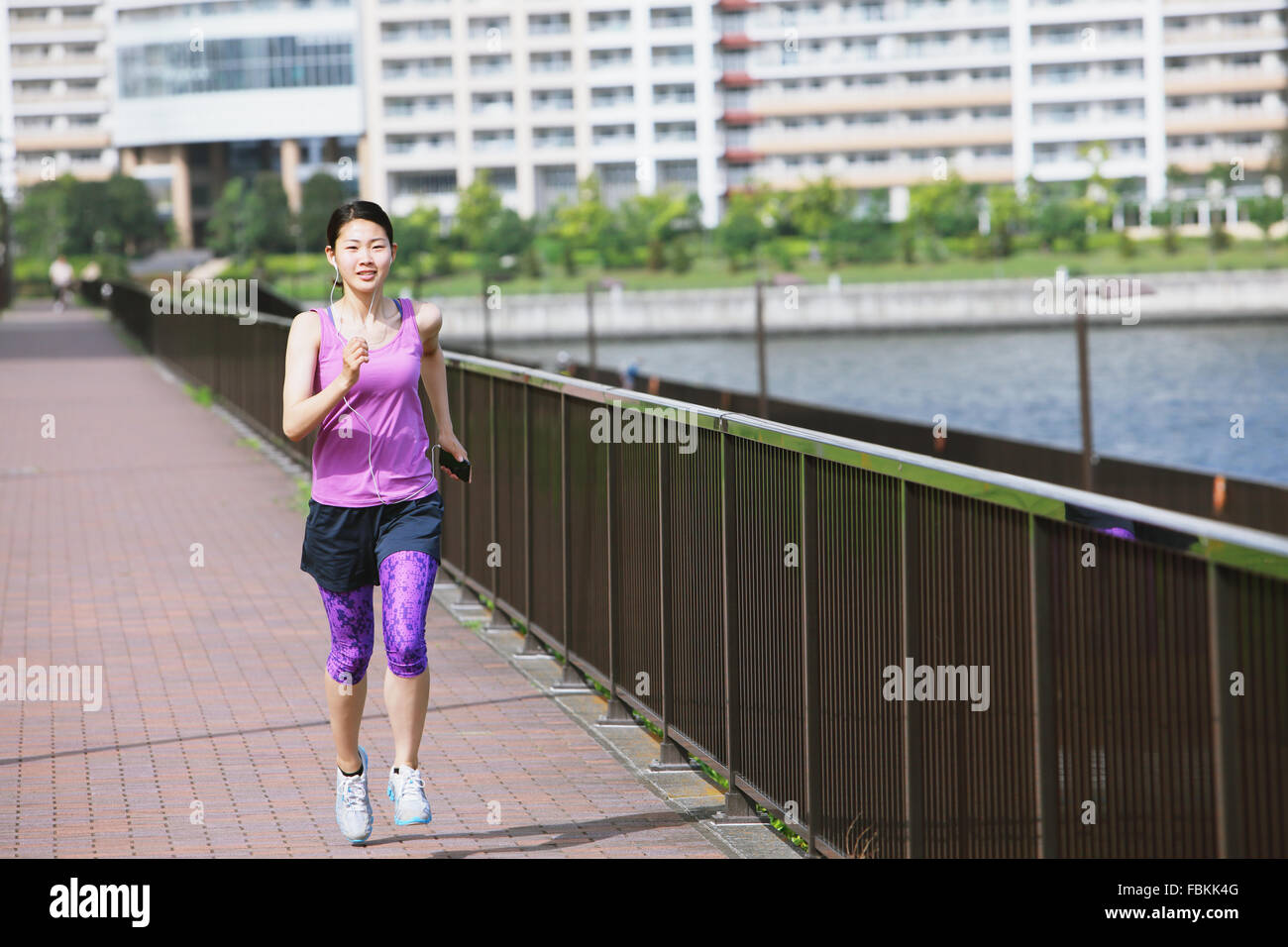 Young Japanese woman running downtown Tokyo Stock Photo - Alamy
