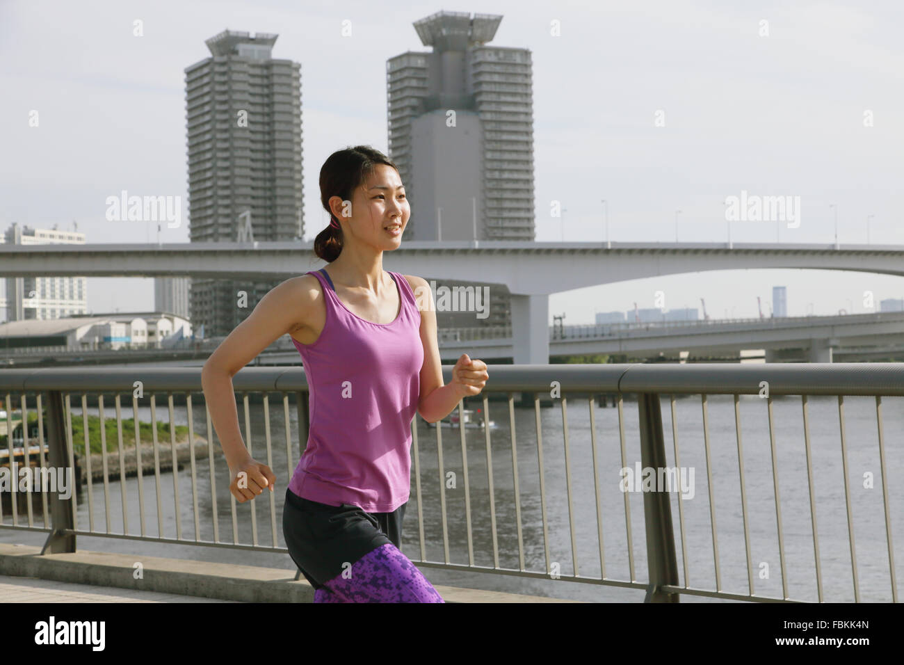 Young Japanese woman running downtown Tokyo Stock Photo - Alamy
