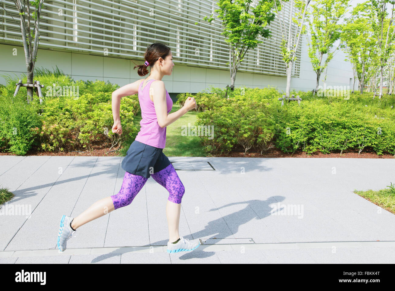 Young Japanese woman running downtown Tokyo Stock Photo - Alamy