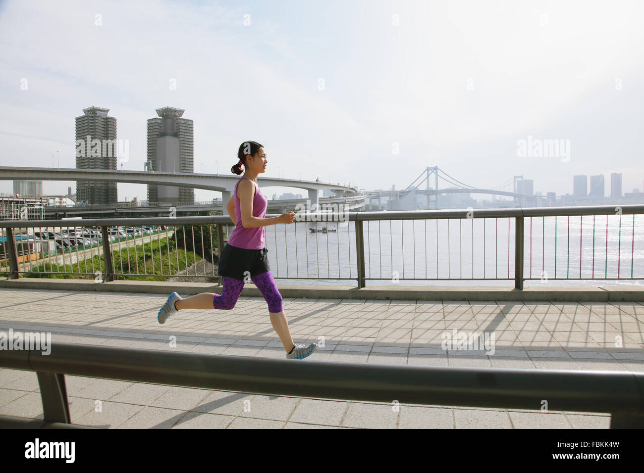 Young Japanese woman running downtown Tokyo Stock Photo - Alamy