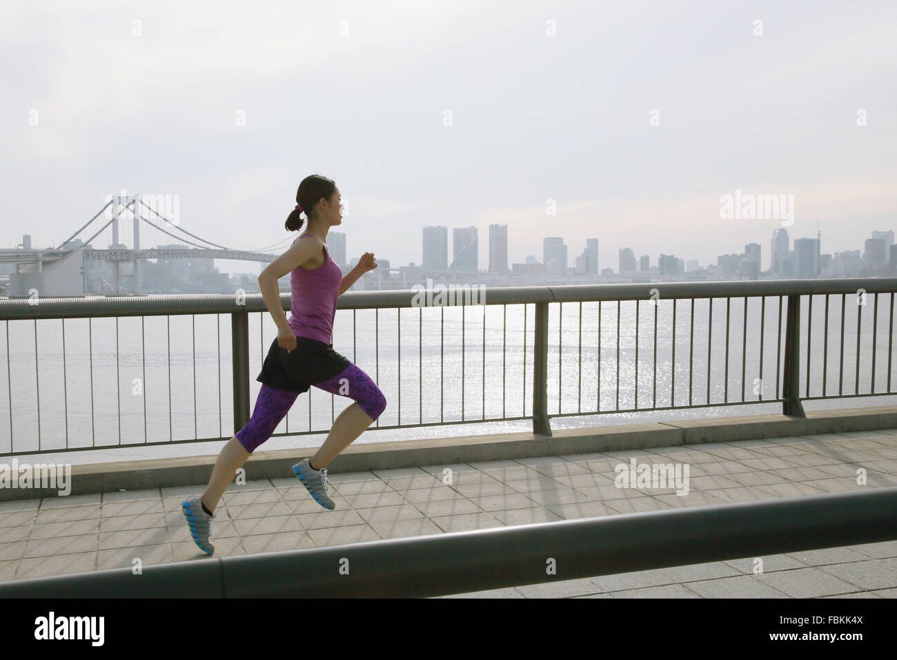 Young Japanese woman running downtown Tokyo Stock Photo - Alamy