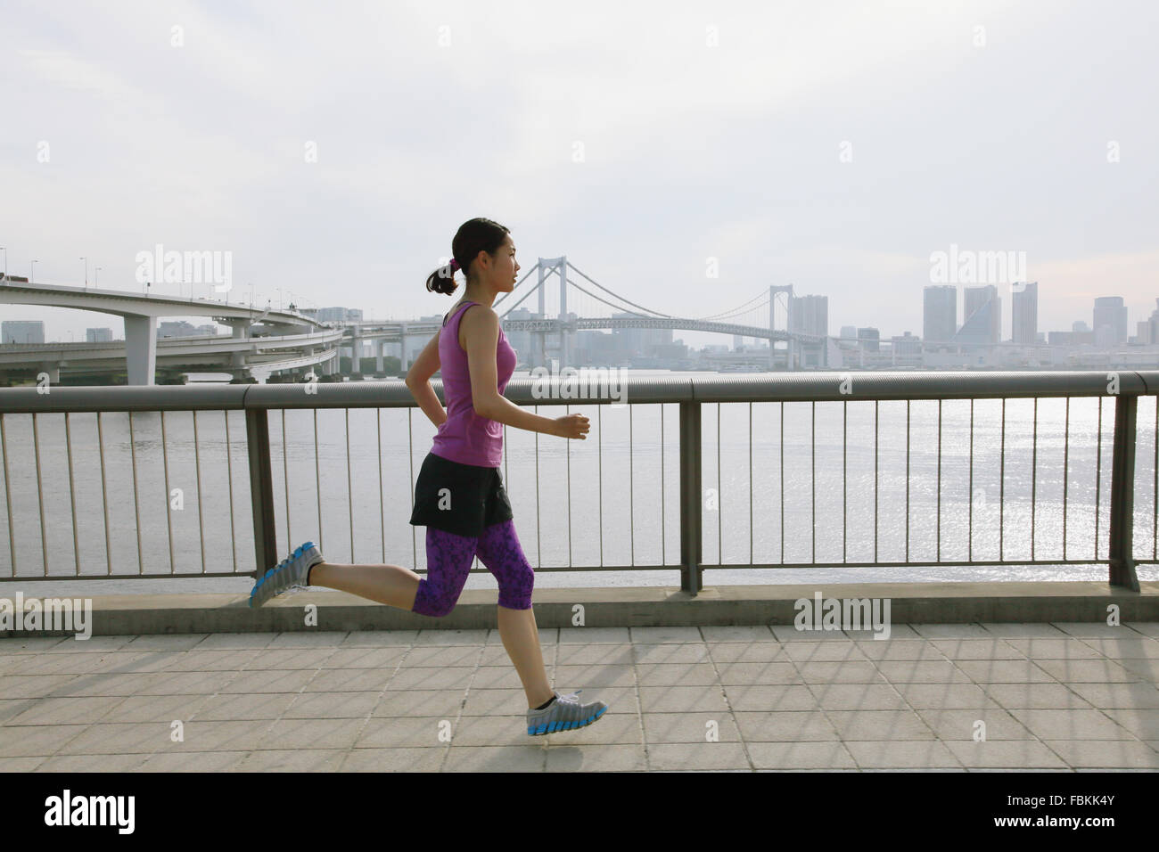 Young Japanese woman running downtown Tokyo Stock Photo - Alamy