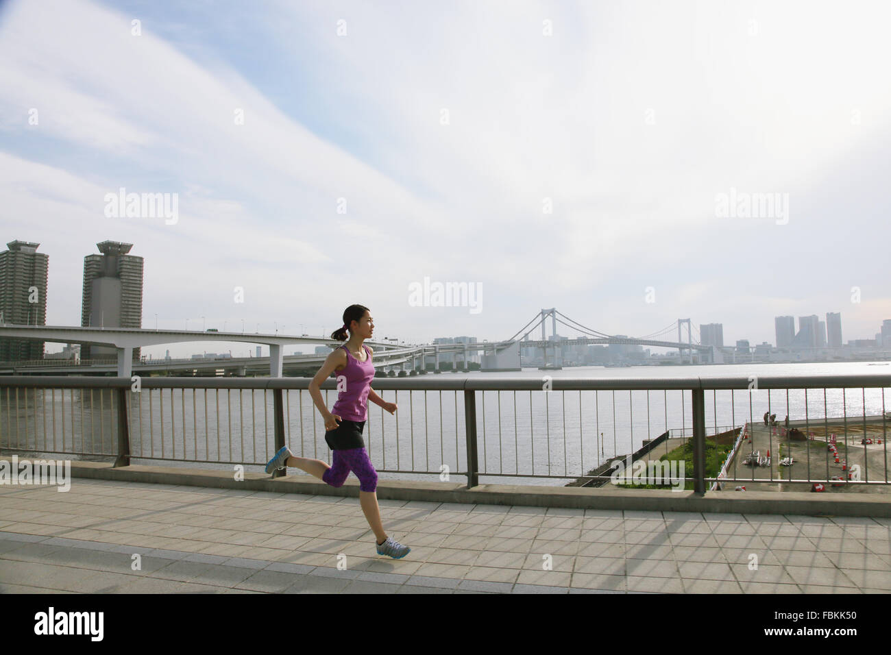 Young Japanese woman running downtown Tokyo Stock Photo - Alamy