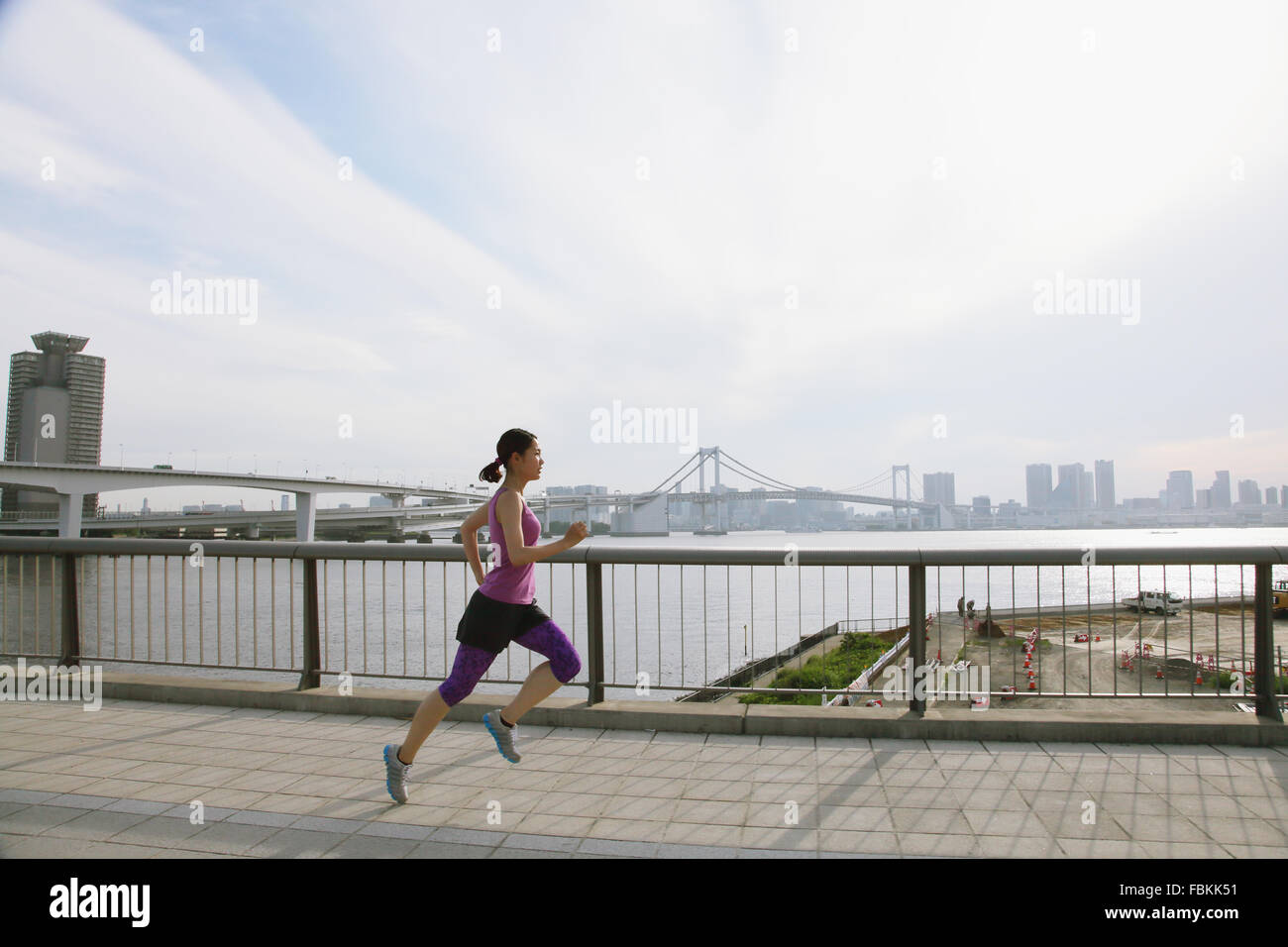 Young Japanese woman running downtown Tokyo Stock Photo - Alamy