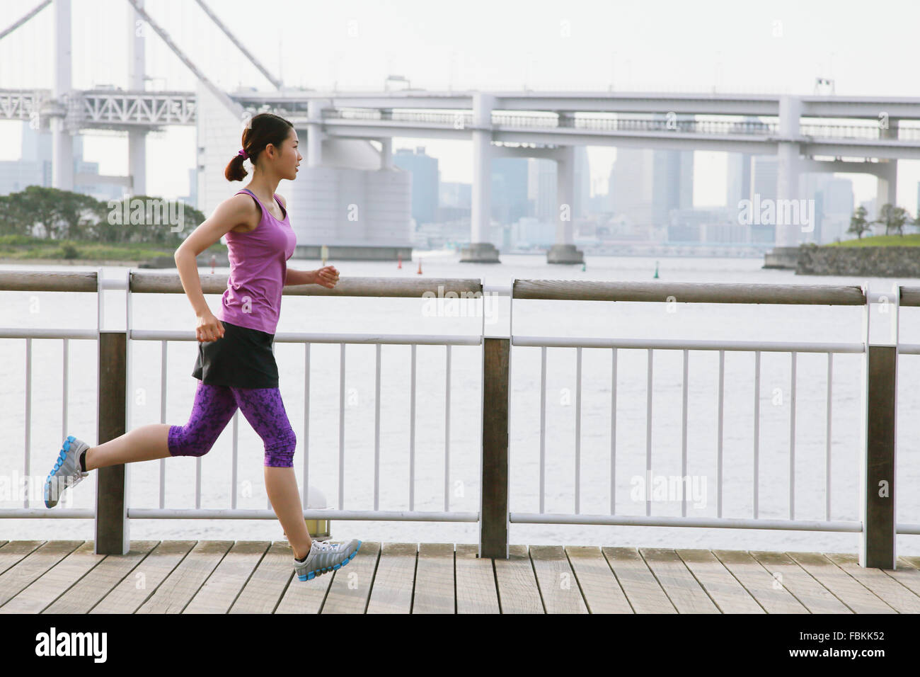 Young Japanese woman running downtown Tokyo Stock Photo - Alamy