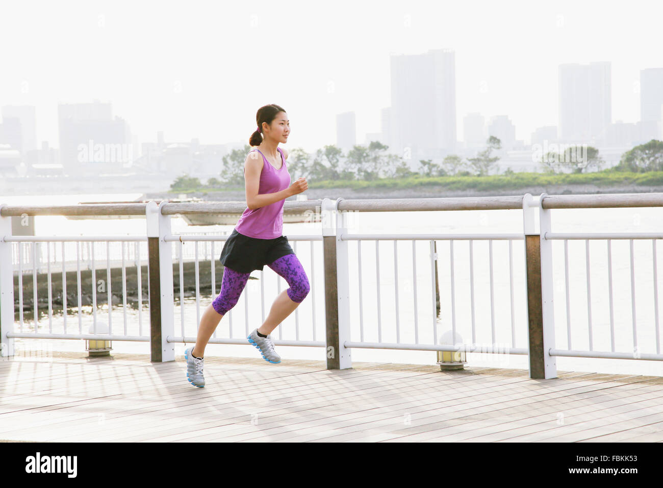 Young Japanese woman running downtown Tokyo Stock Photo - Alamy