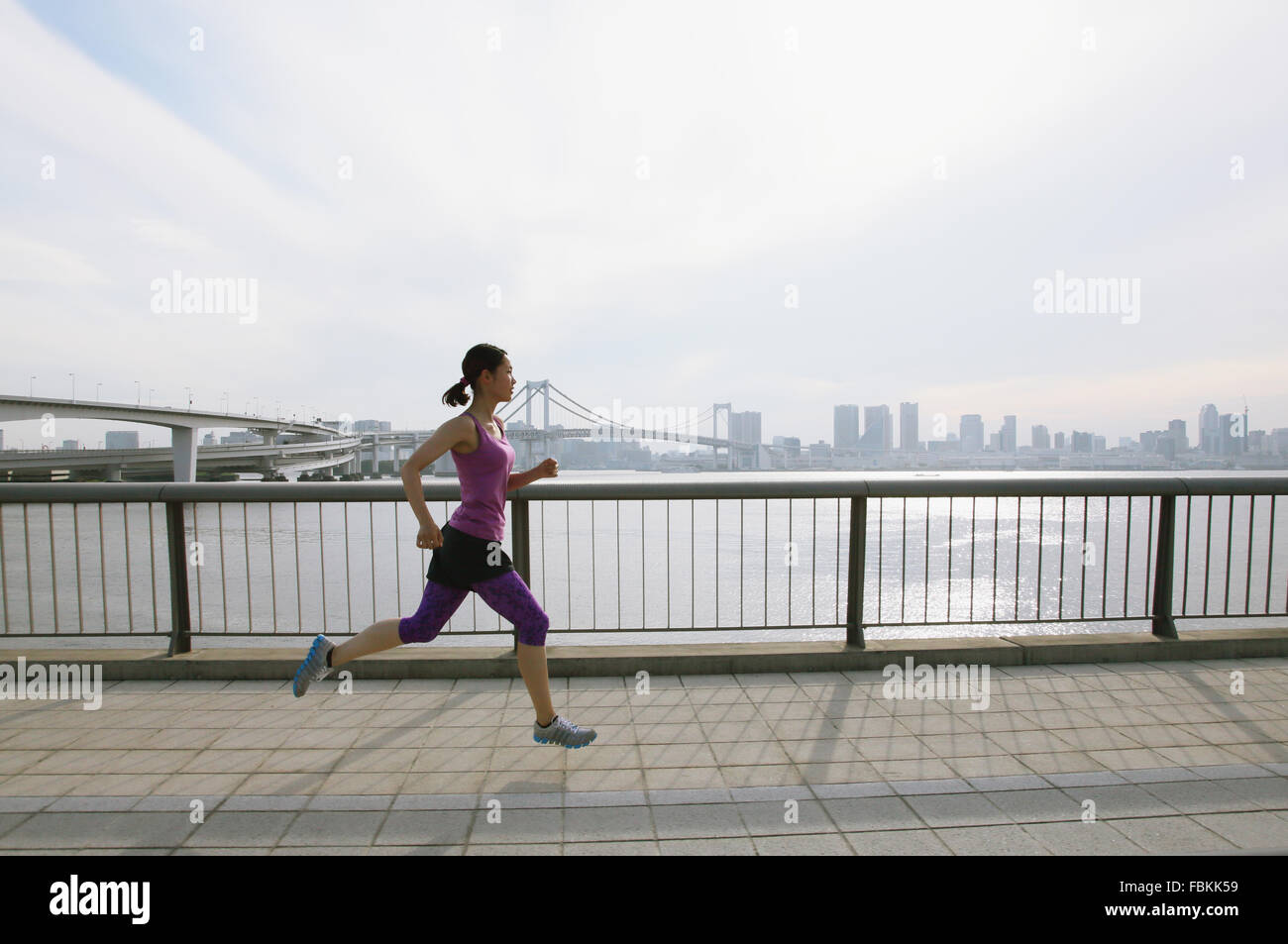 Young Japanese woman running downtown Tokyo Stock Photo - Alamy