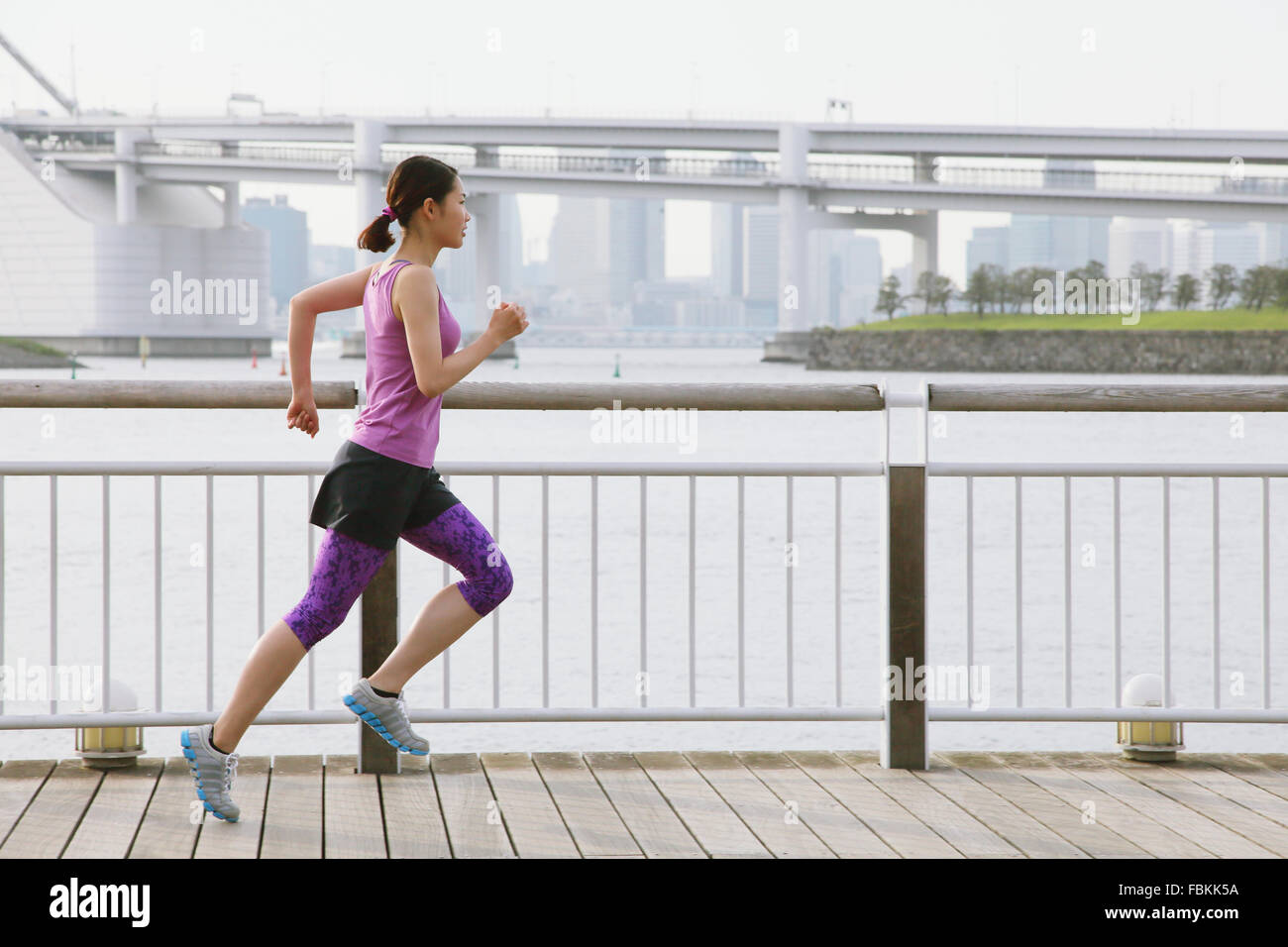 Young Japanese woman running downtown Tokyo Stock Photo - Alamy