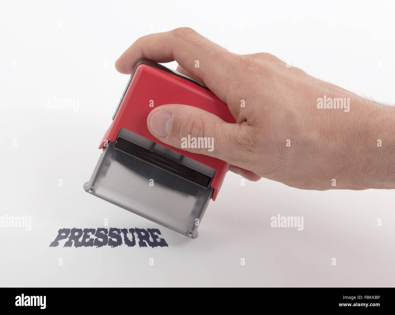 Plastic stamp in hand, isolated on white - Pressure Stock Photo - Alamy