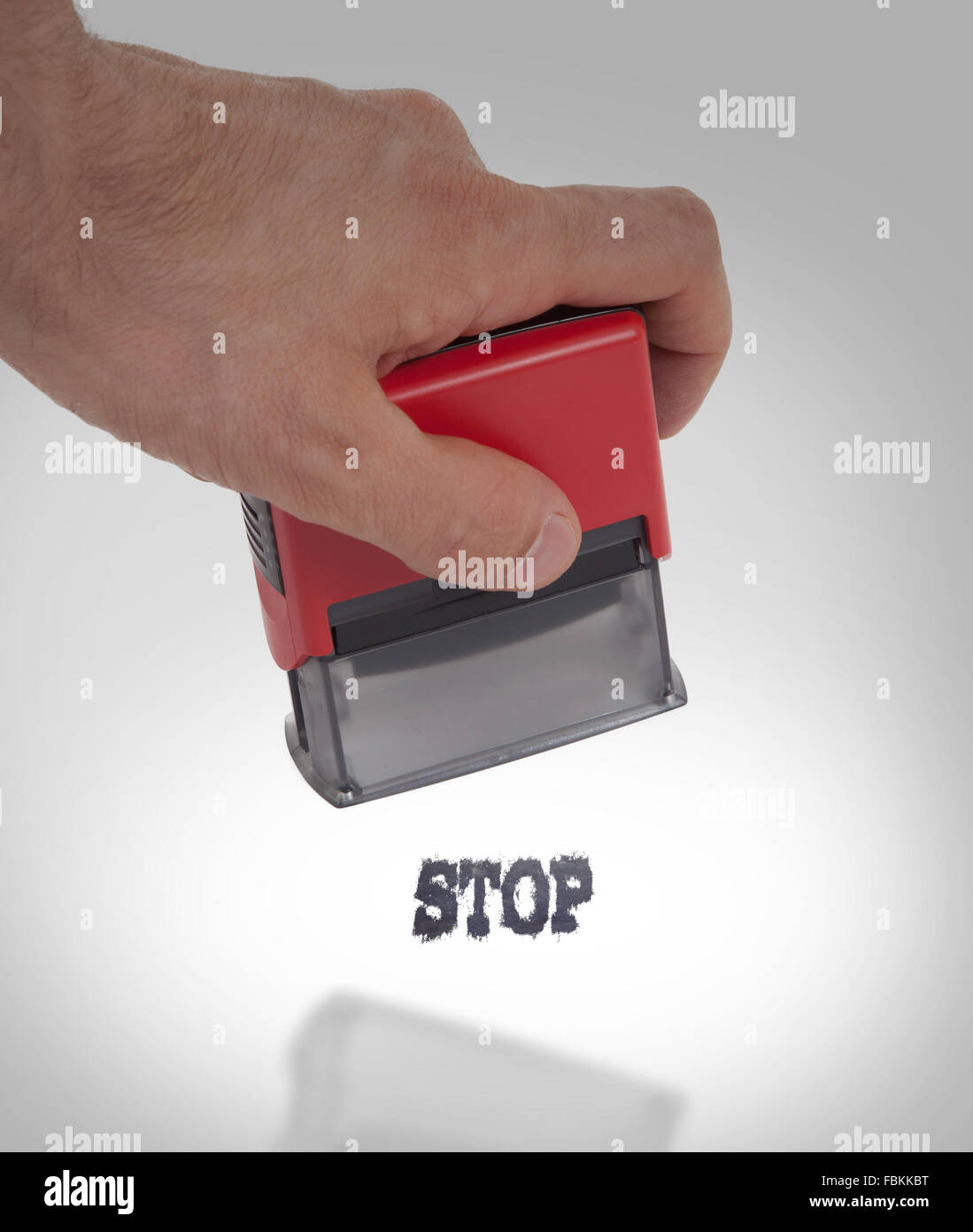 Plastic stamp in hand, isolated on white - Stop Stock Photo - Alamy