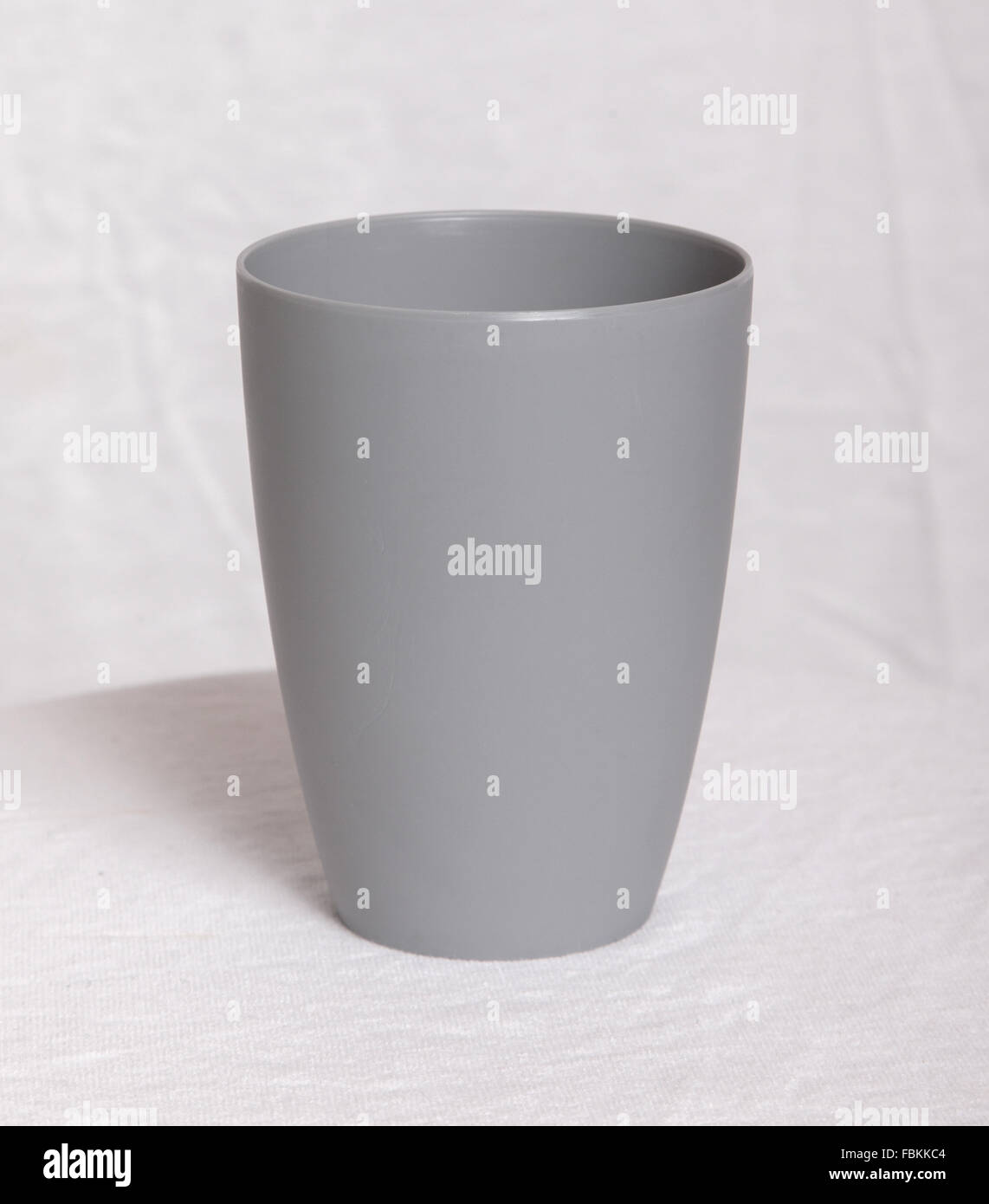 Empty plastic cup isolated on white table sheet Stock Photo - Alamy