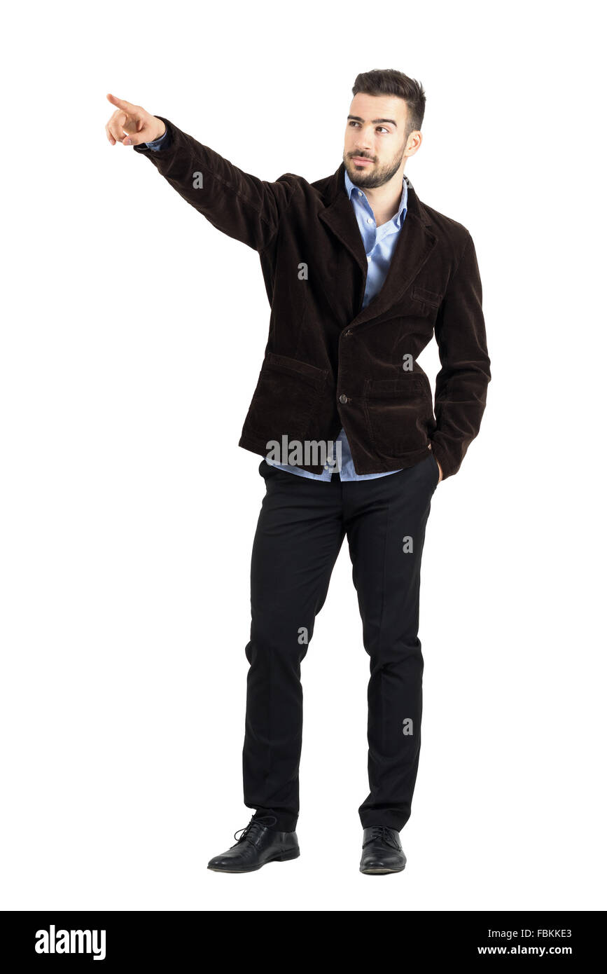 Confident relaxed man directional pointing at distance looking away ...