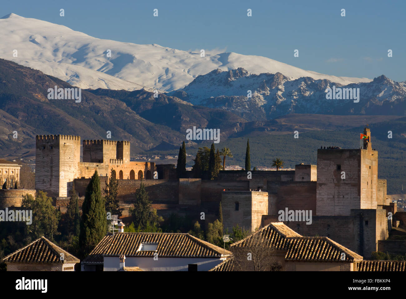 The Alhambra of Granada in Spain with Sierra Nevada snowy mountains as ...