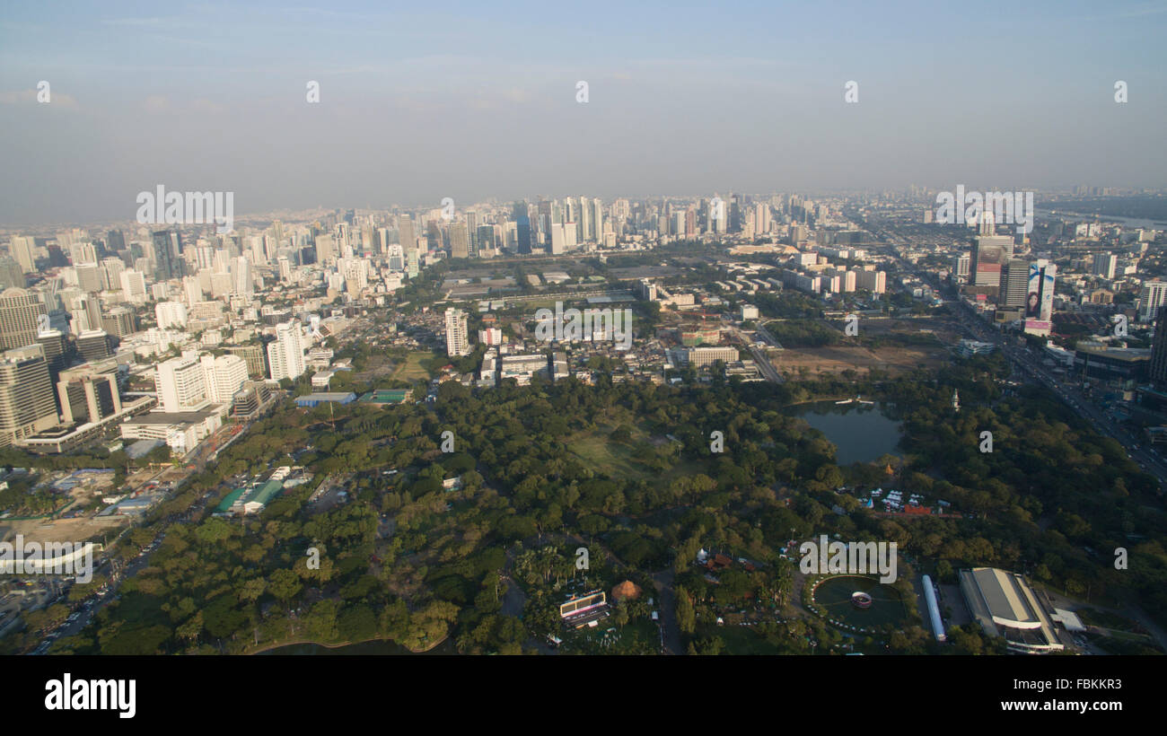 A aerial drone view over Lumpini Park in Bangkok, Thailand looking east ...