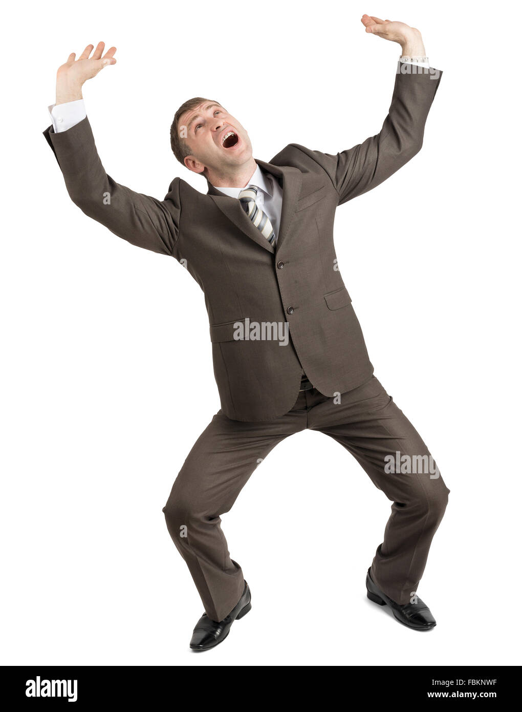 Scared businessman looking up Stock Photo - Alamy