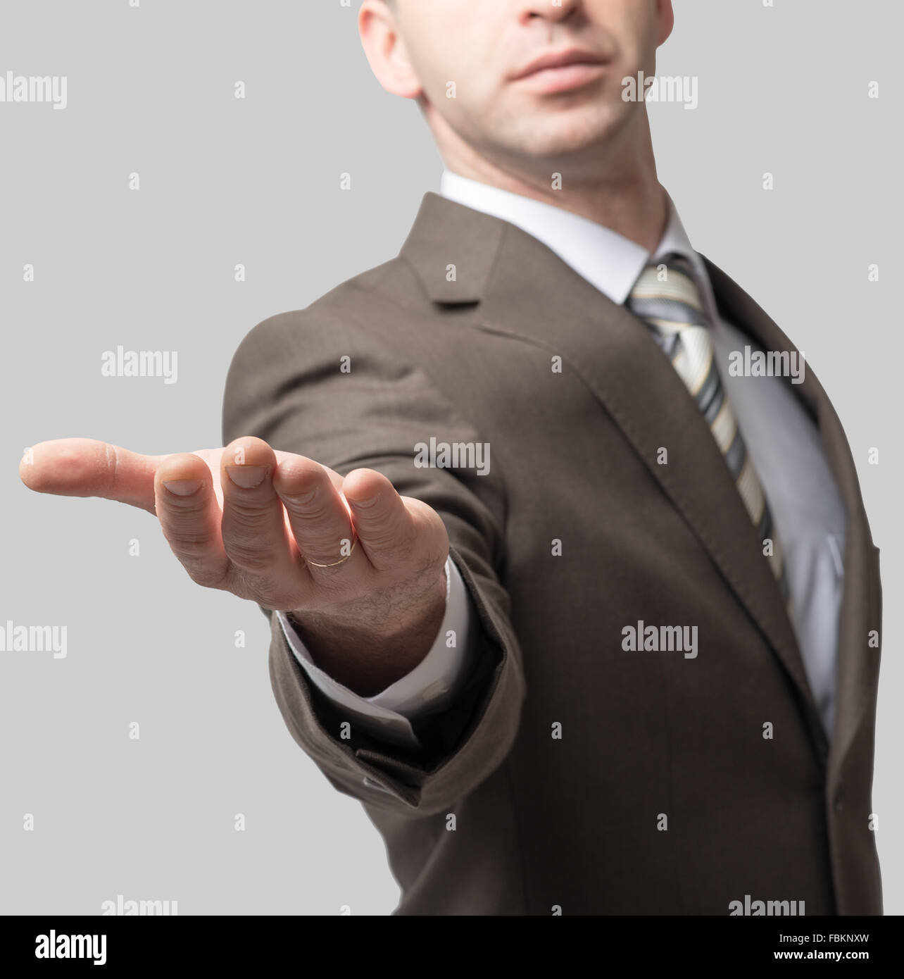 Businessman with outstretched hand Stock Photo - Alamy