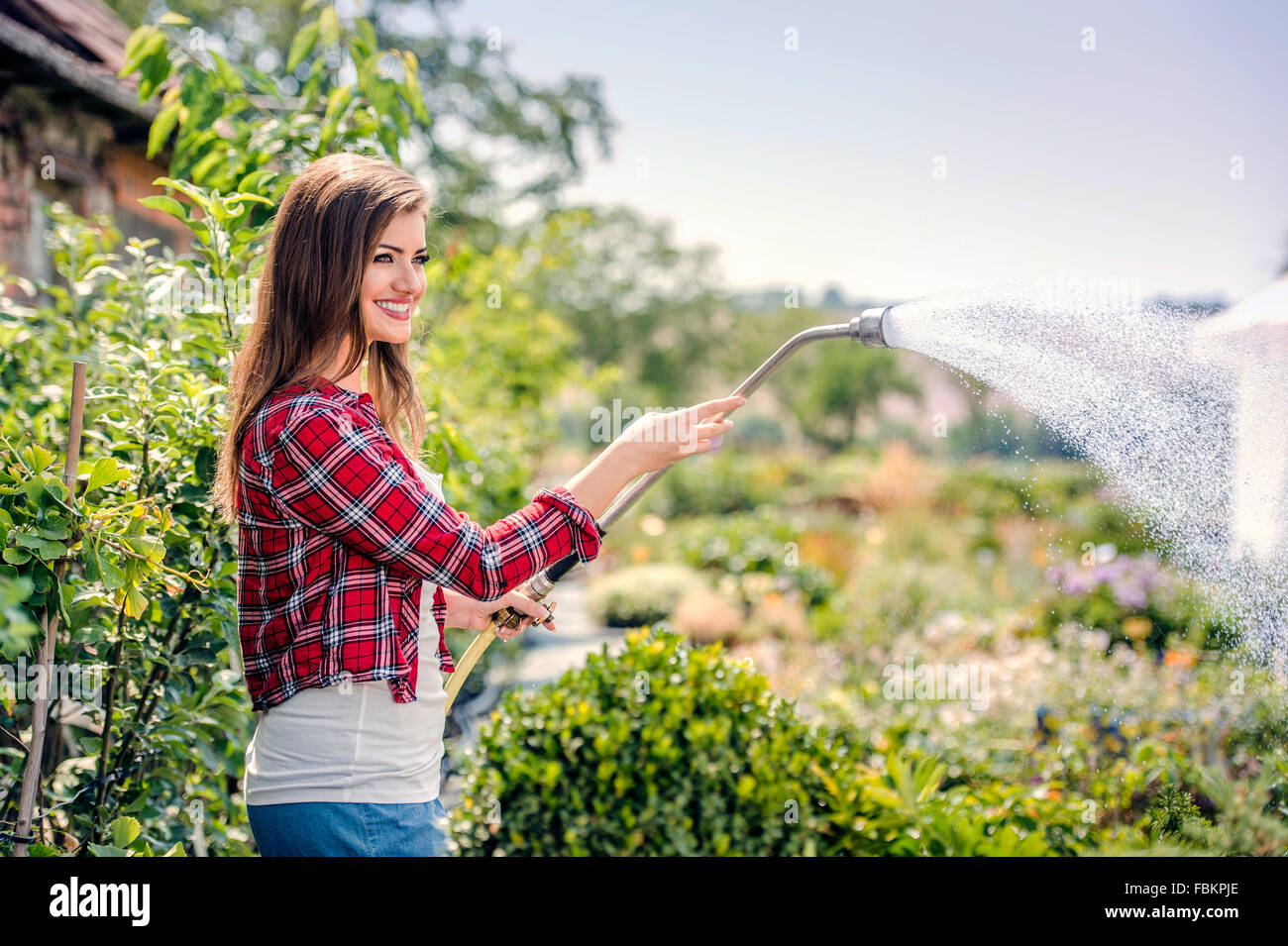 Beautiful young woman gardening Stock Photo - Alamy