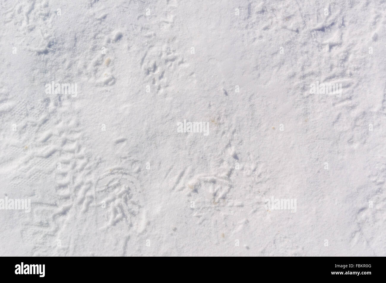 Footprints in packed snow make a wintery background image Stock Photo ...