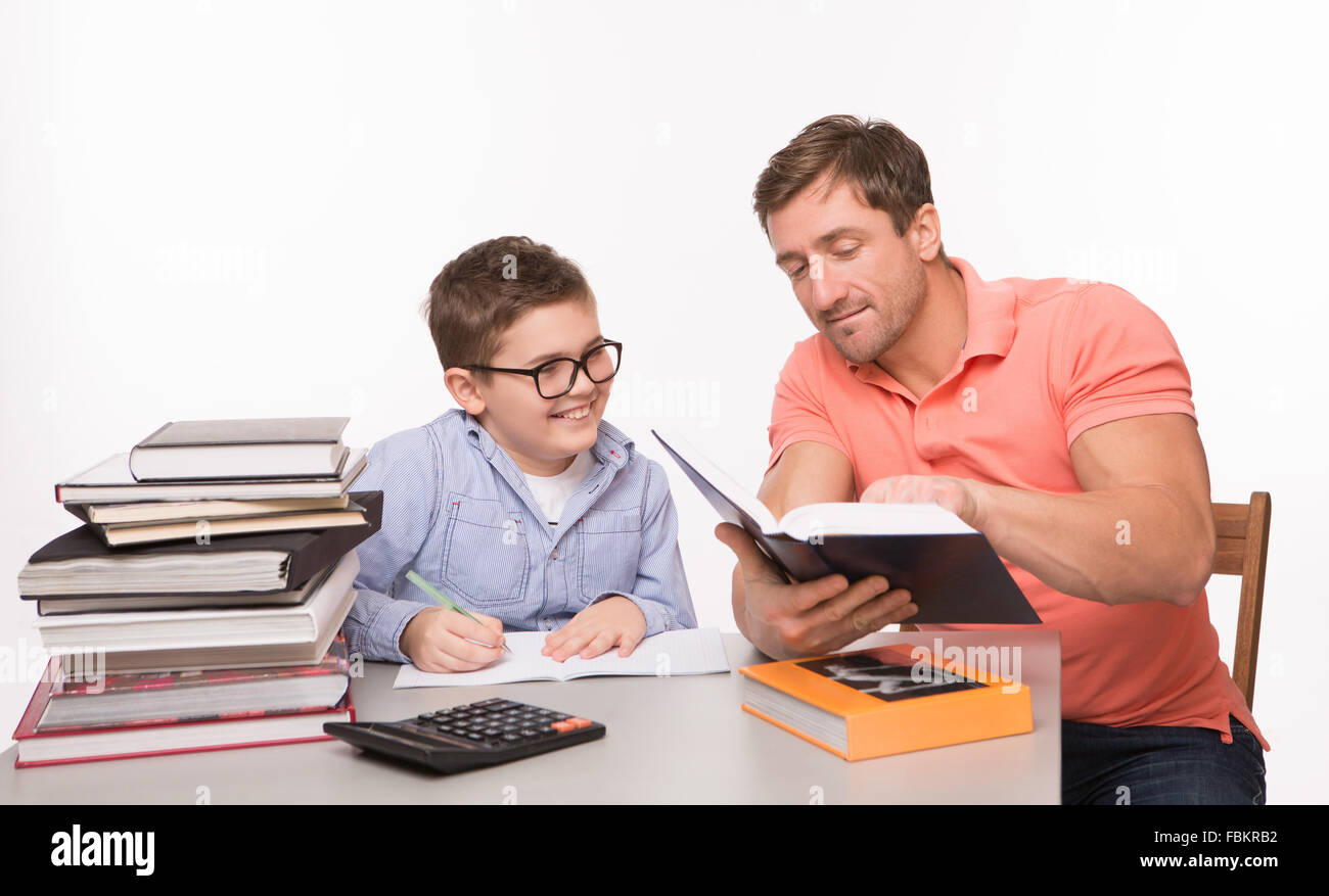 Boy doing homework together with his father Stock Photo - Alamy