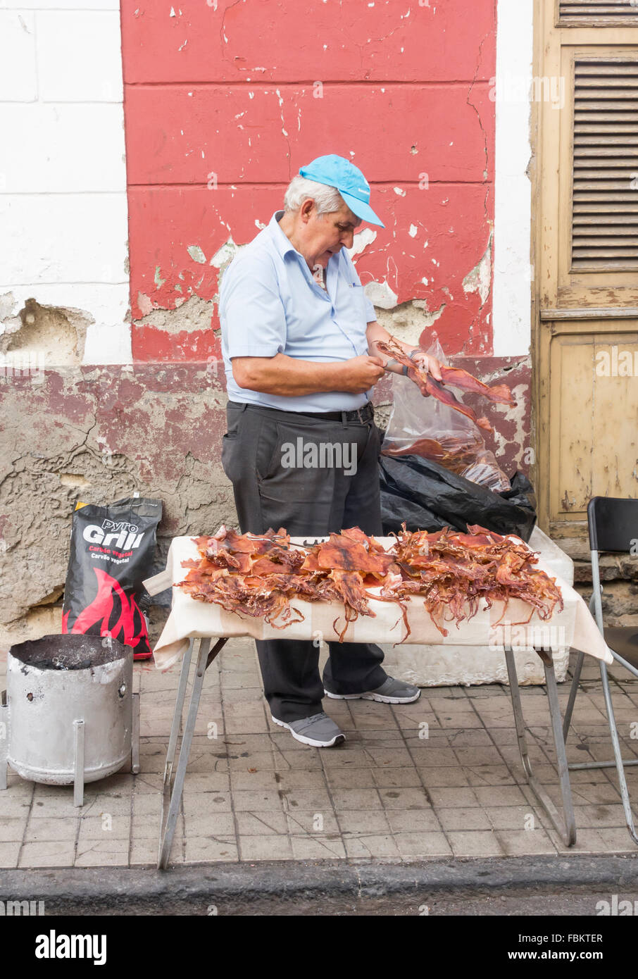 Man selling dried fish on street in Spain Stock Photo - Alamy
