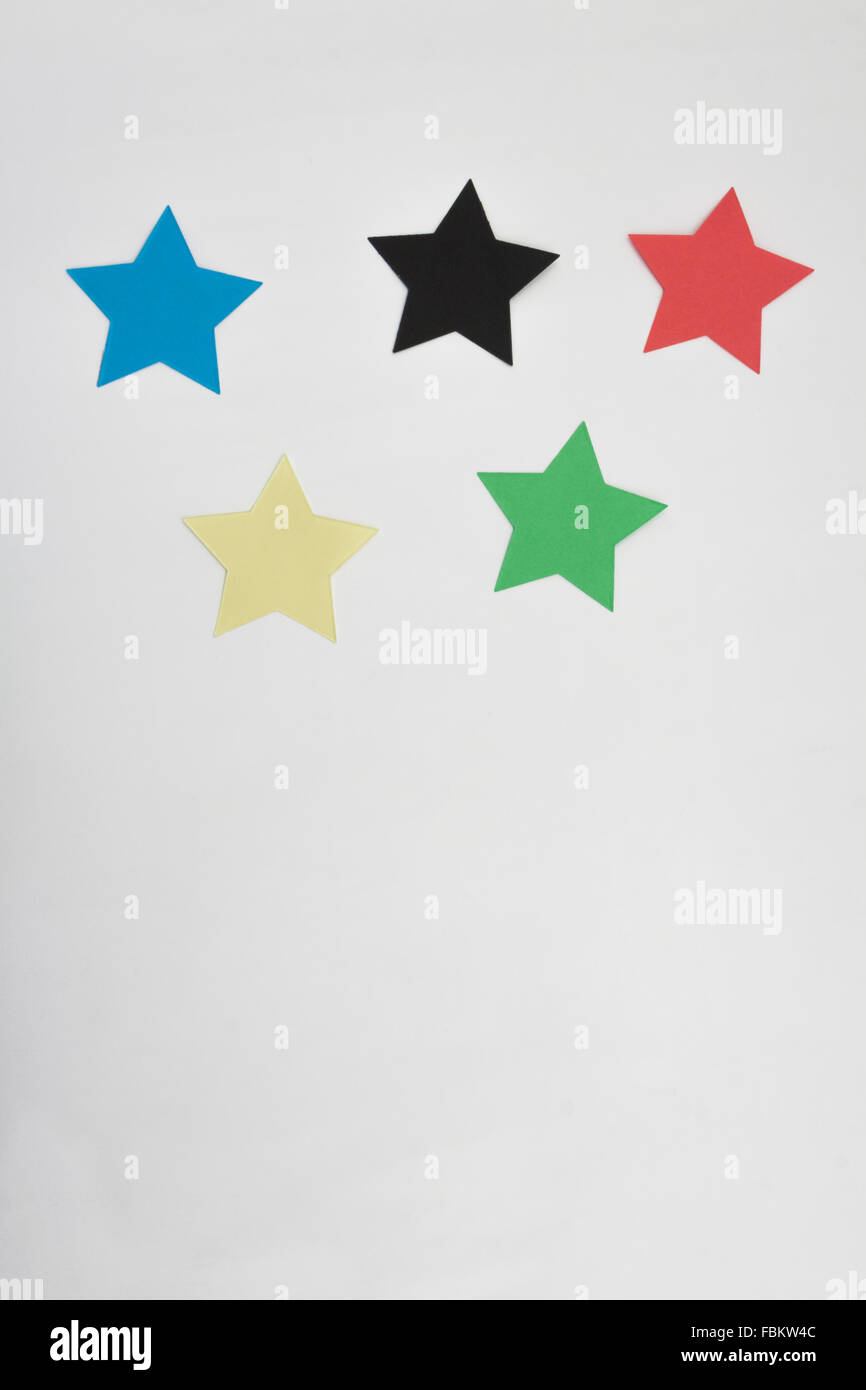 a vertical overhead view of five paper stars with the color od the ...