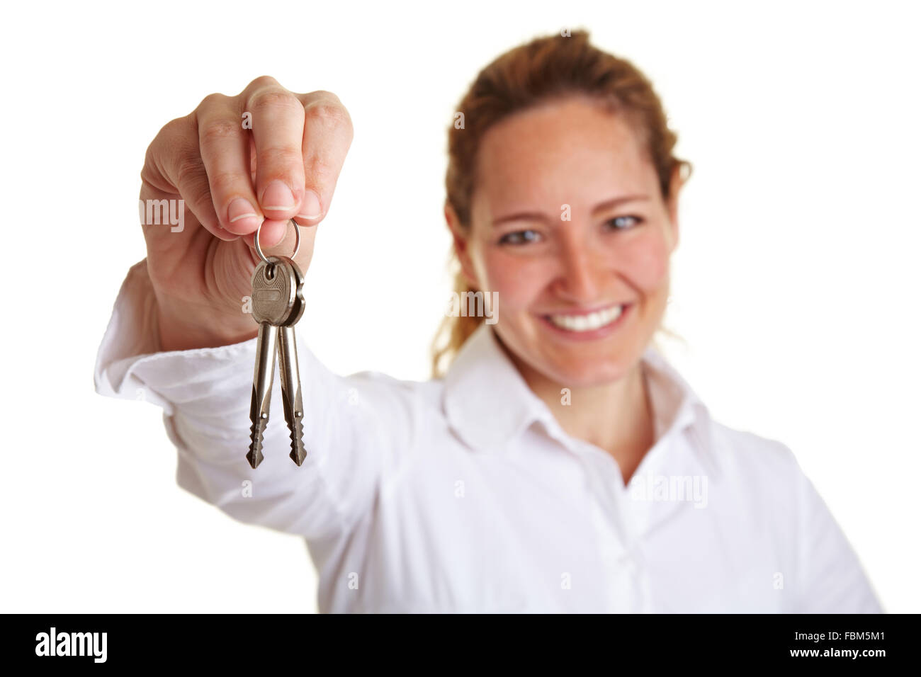 Happy business woman holding two keys in her hand Stock Photo - Alamy