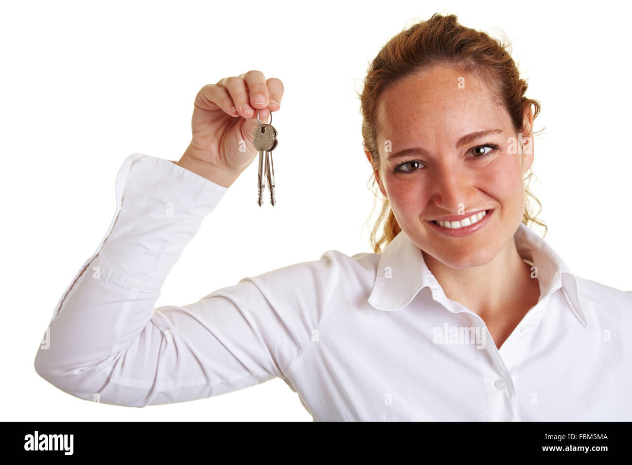 Happy business woman showing two keys in her hand Stock Photo - Alamy