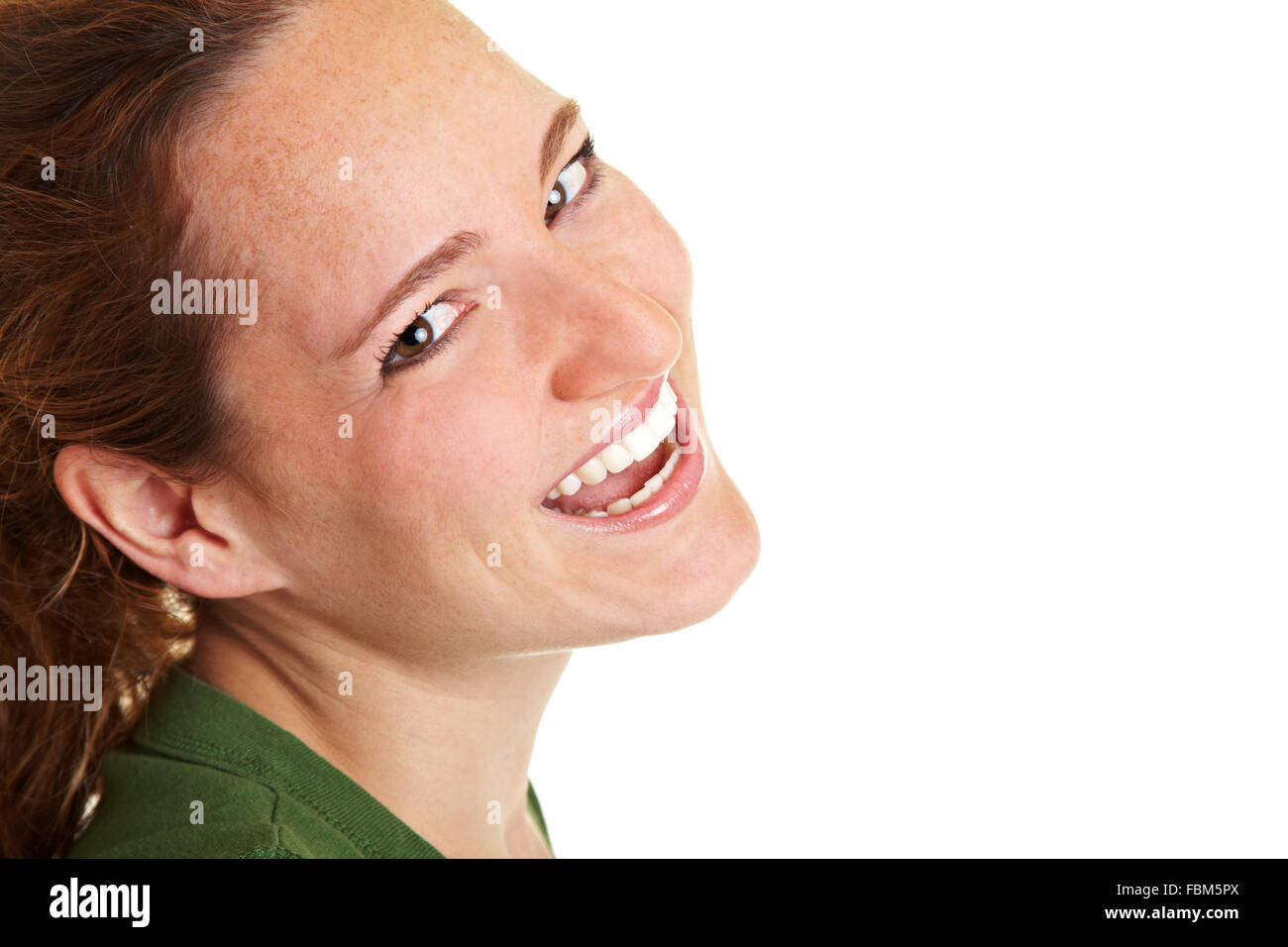 Happy young smiling woman looking sideways into the camera Stock Photo ...