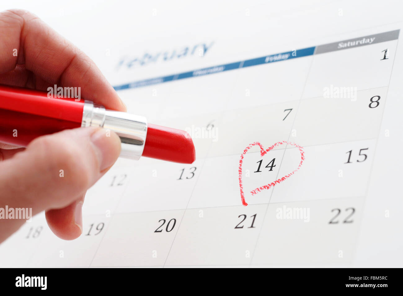 February calendar page with lipstick painted little red heart marking ...