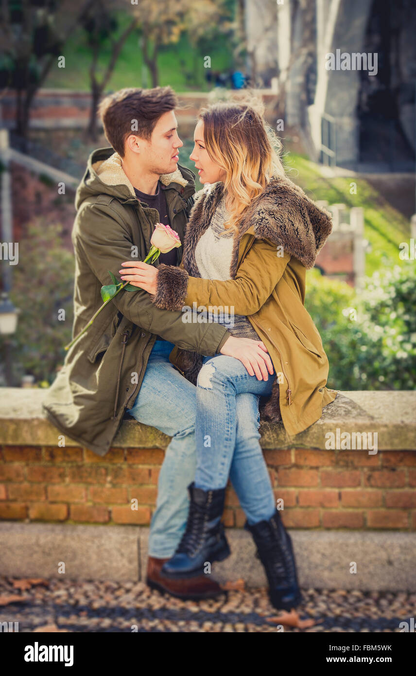 Candid Portrait Of Beautiful European Couple With Rose In Love Kissing