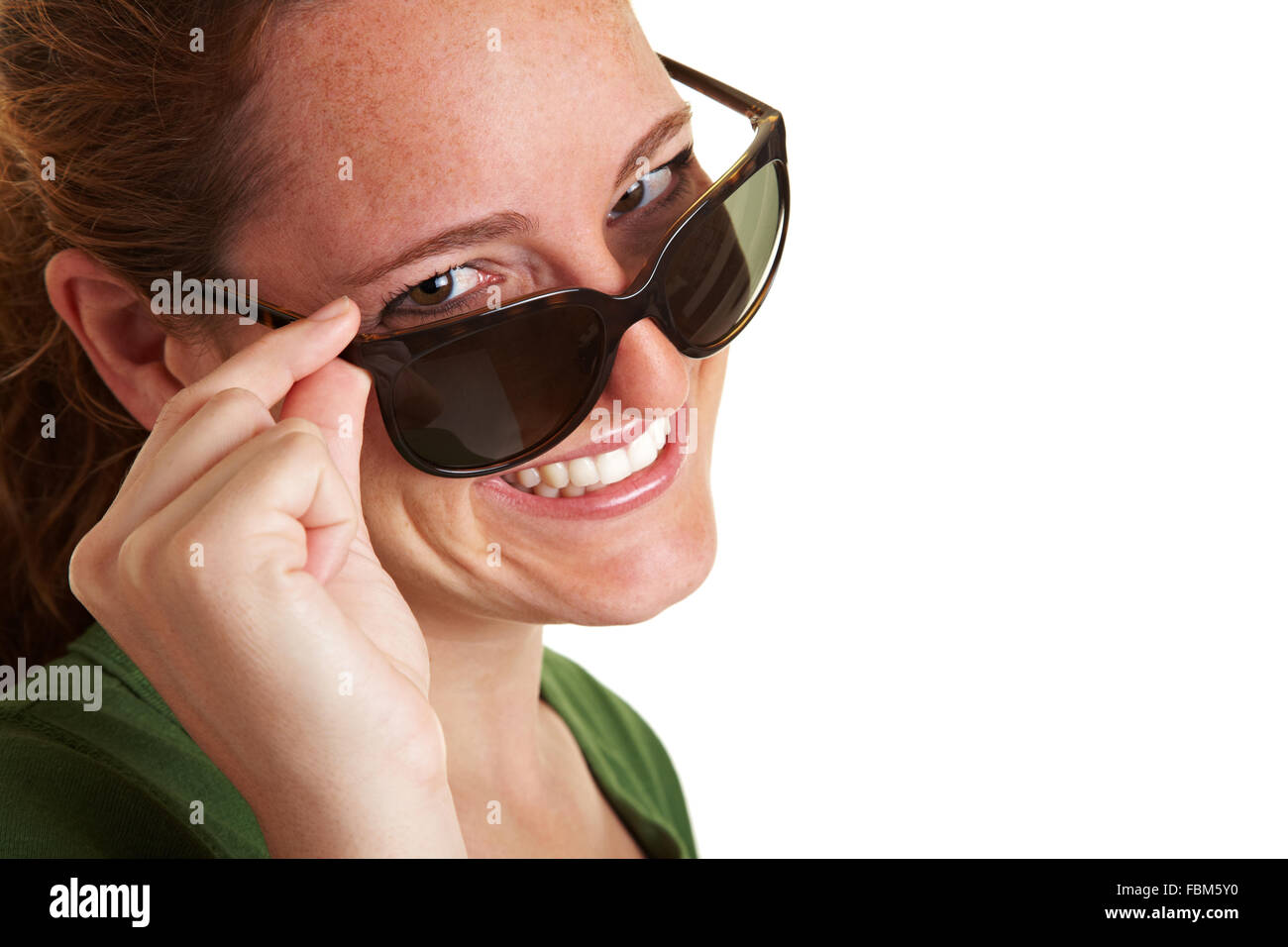 Happy smiling woman looking over the top of her sunglasses Stock Photo ...