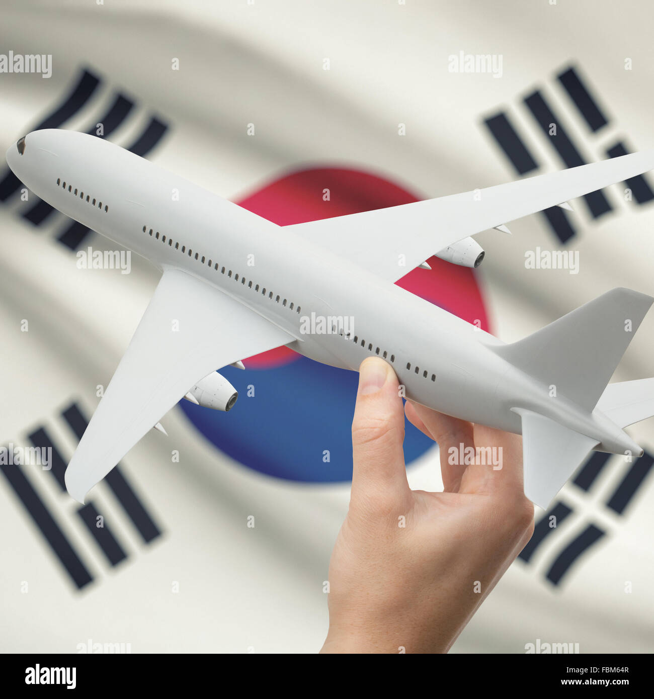 Airplane in hand with national flag on background series - South Korea ...