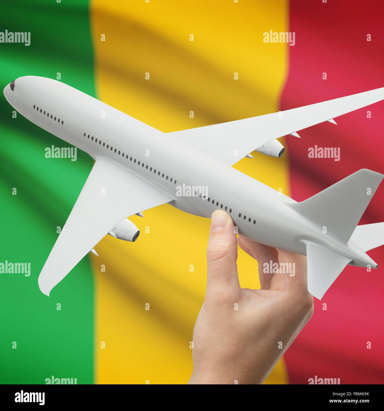 Airplane in hand with national flag on background series - Mali Stock ...