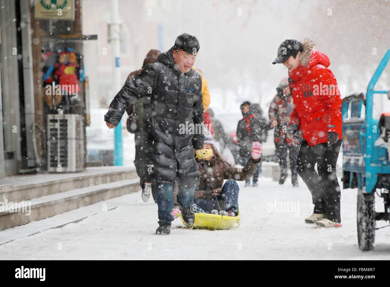 Weihai, China's Shandong Province. 18th Jan, 2016. People walk in snow ...