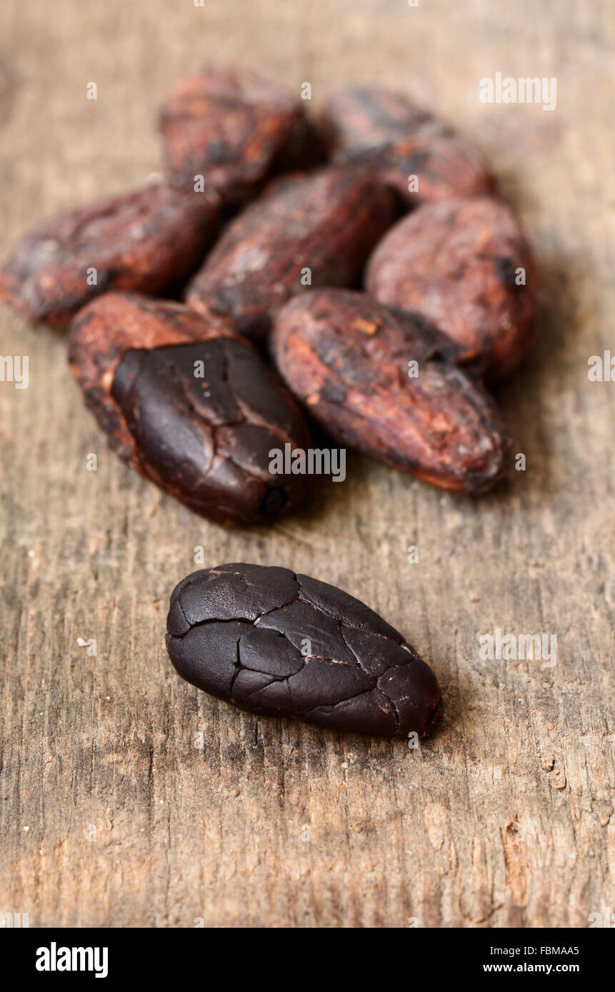 Raw Cocoa beans on a dark background Stock Photo - Alamy