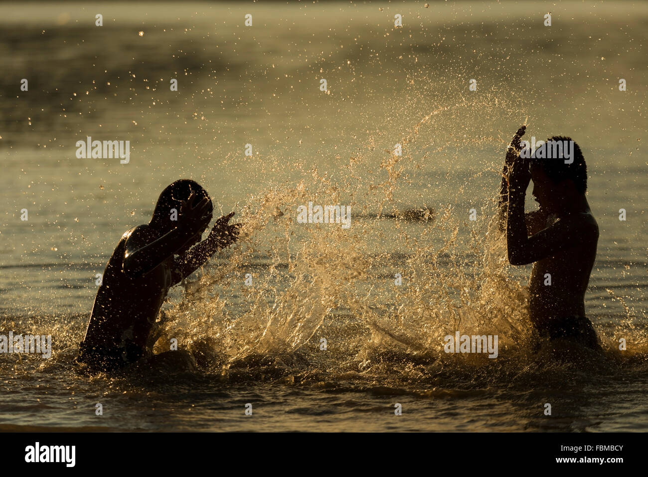 Two boys Splashing in the river, Thailand Stock Photo - Alamy
