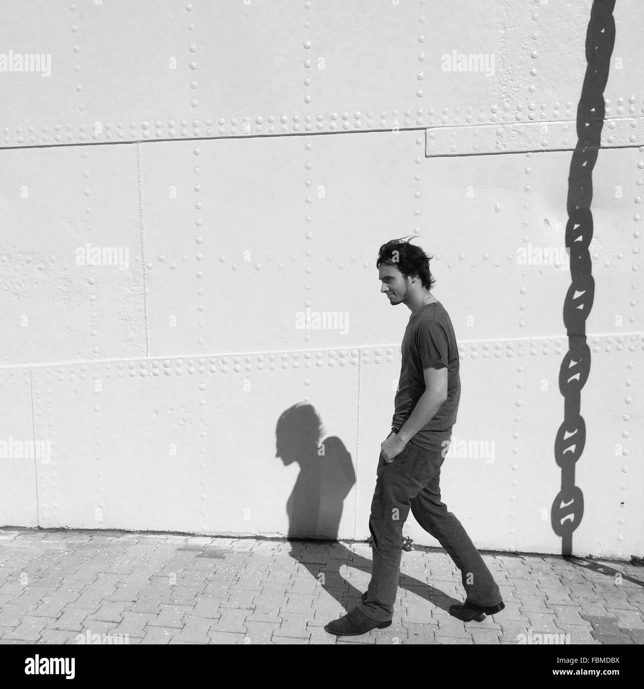Man Walking Side View Sunlight Black and White Stock Photos & Images ...