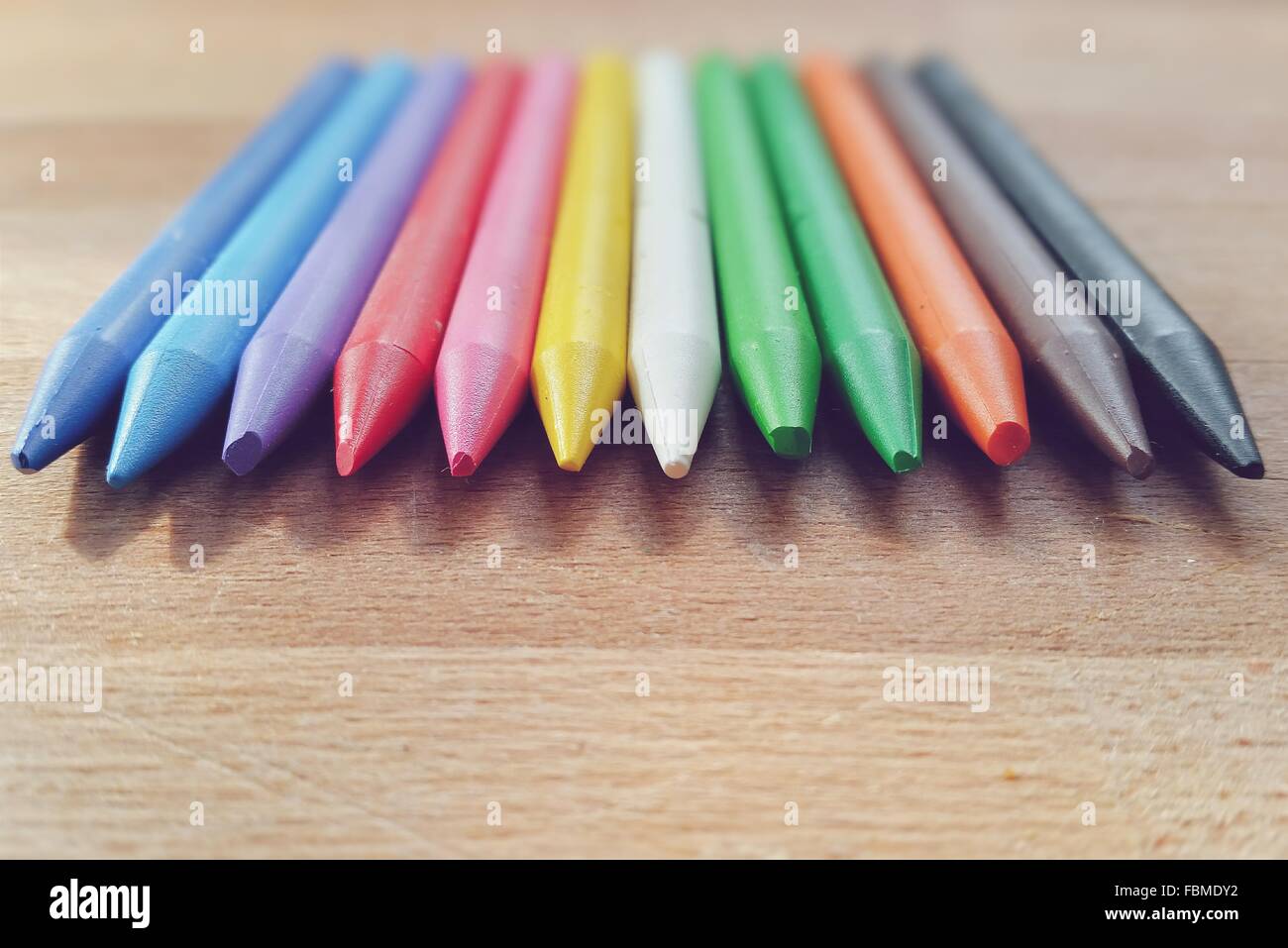 Twelve colored pencils lying on table Stock Photo - Alamy