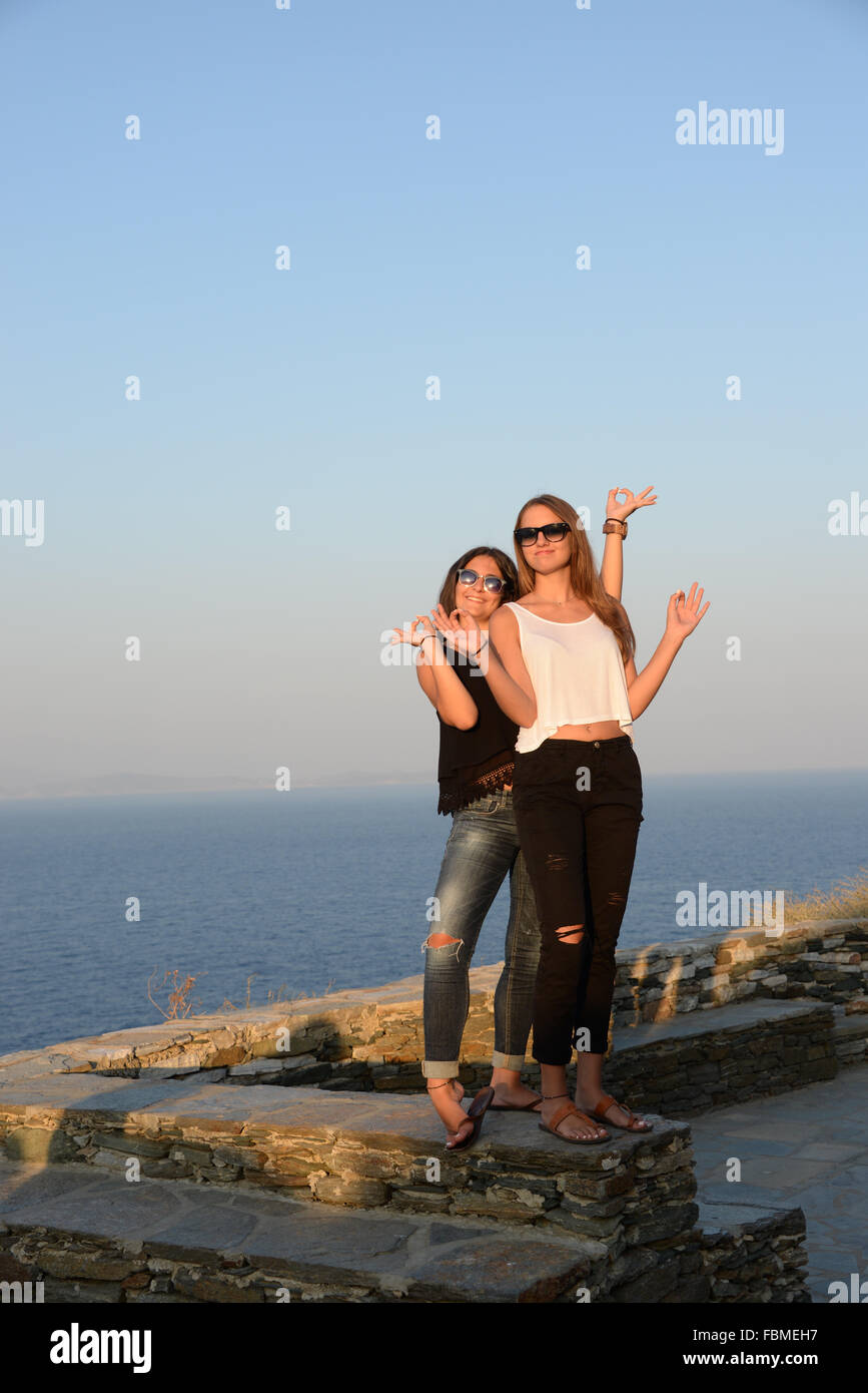 Two girls messing about, Cyclades, Greece Stock Photo - Alamy