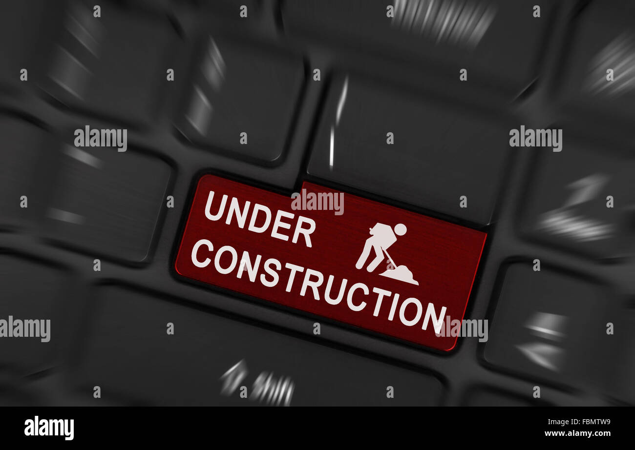 Under construction - Maintenance icon on black laptop keyboard button ...