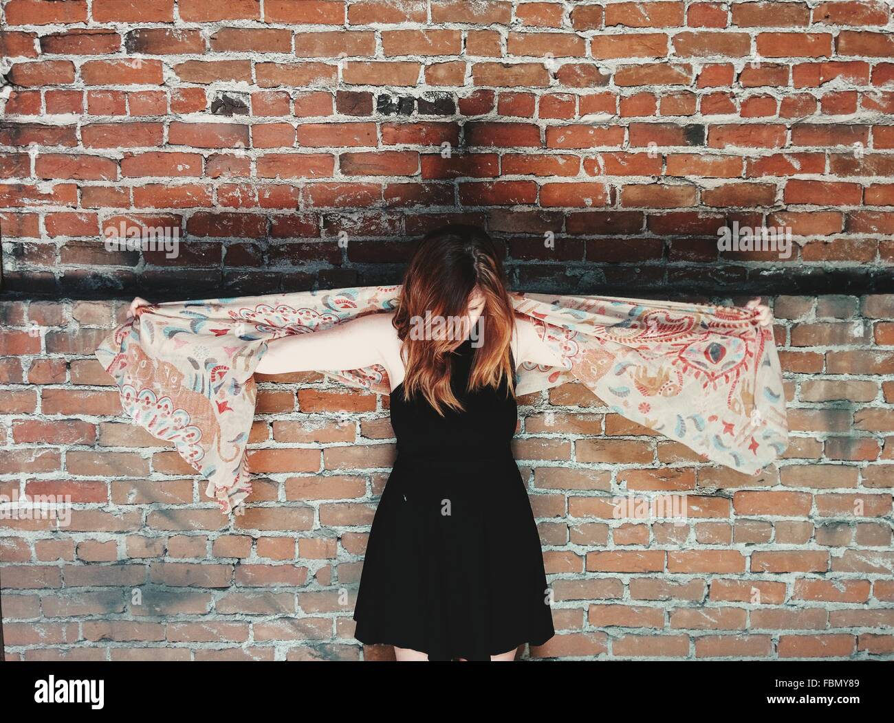 Woman Standing Against Brick Wall High Resolution Stock Photography and ...