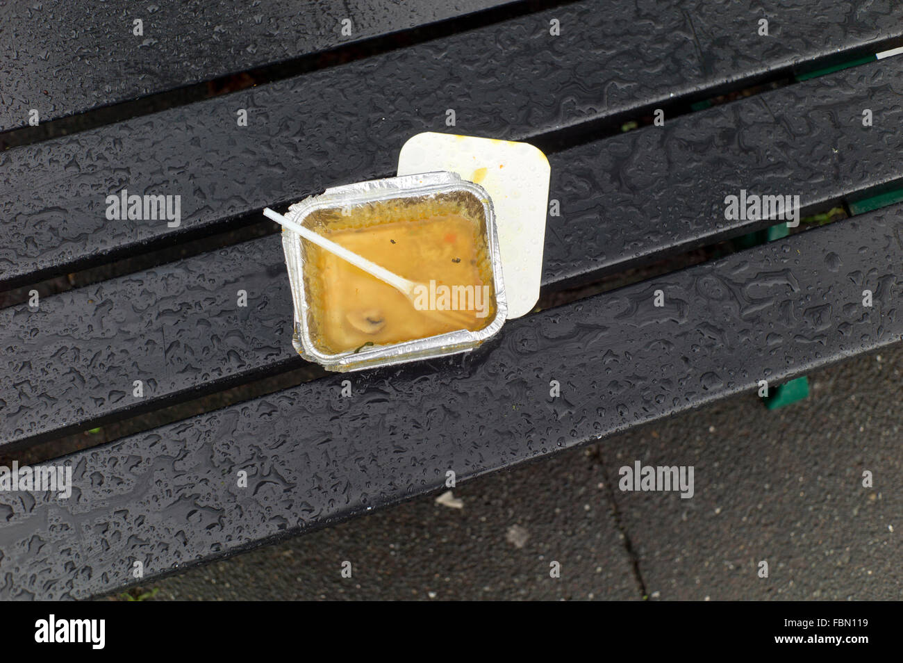 Waterlogged empty take-away container on wet bench Stock Photo - Alamy