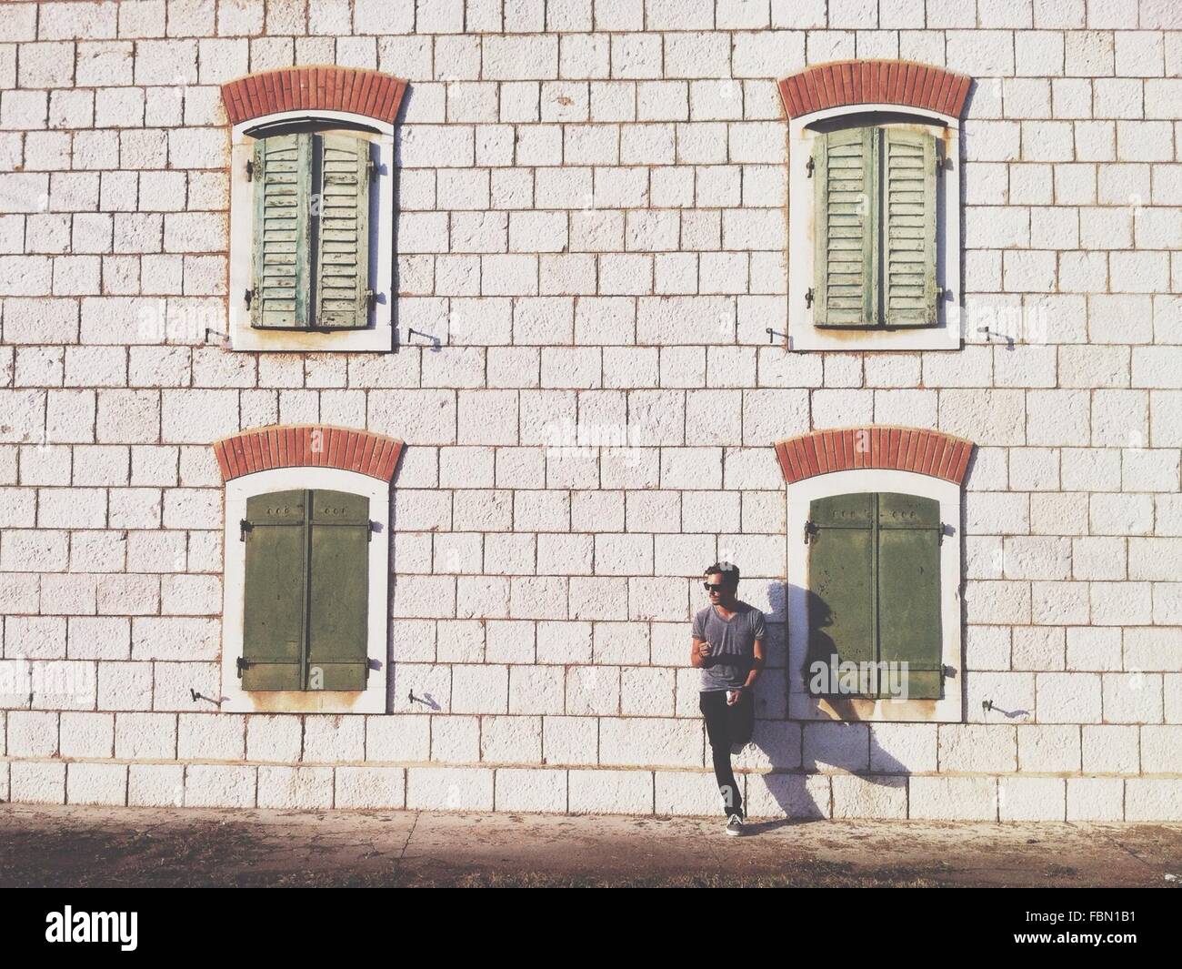 Man leaning against wall hi-res stock photography and images - Alamy