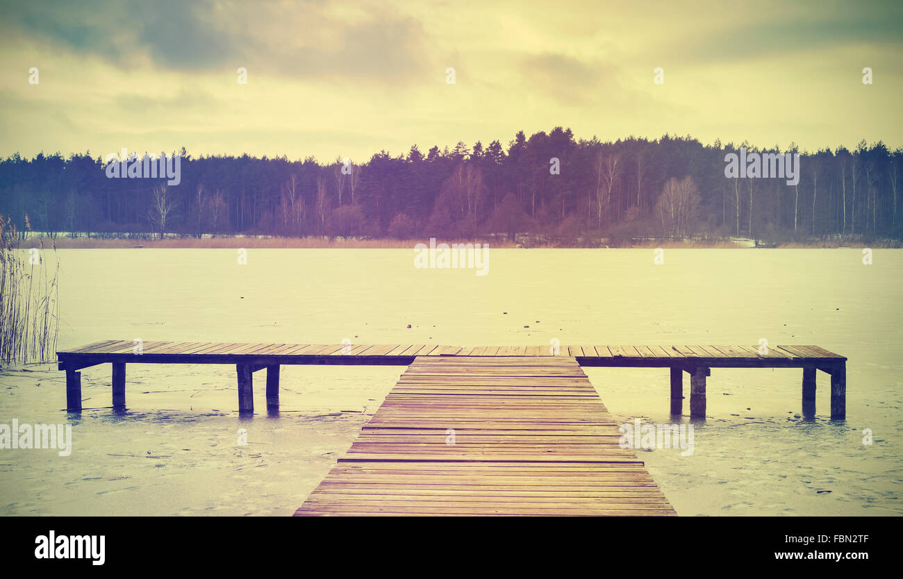 Vintage retro stylized image of a pier on frozen lake Stock Photo - Alamy