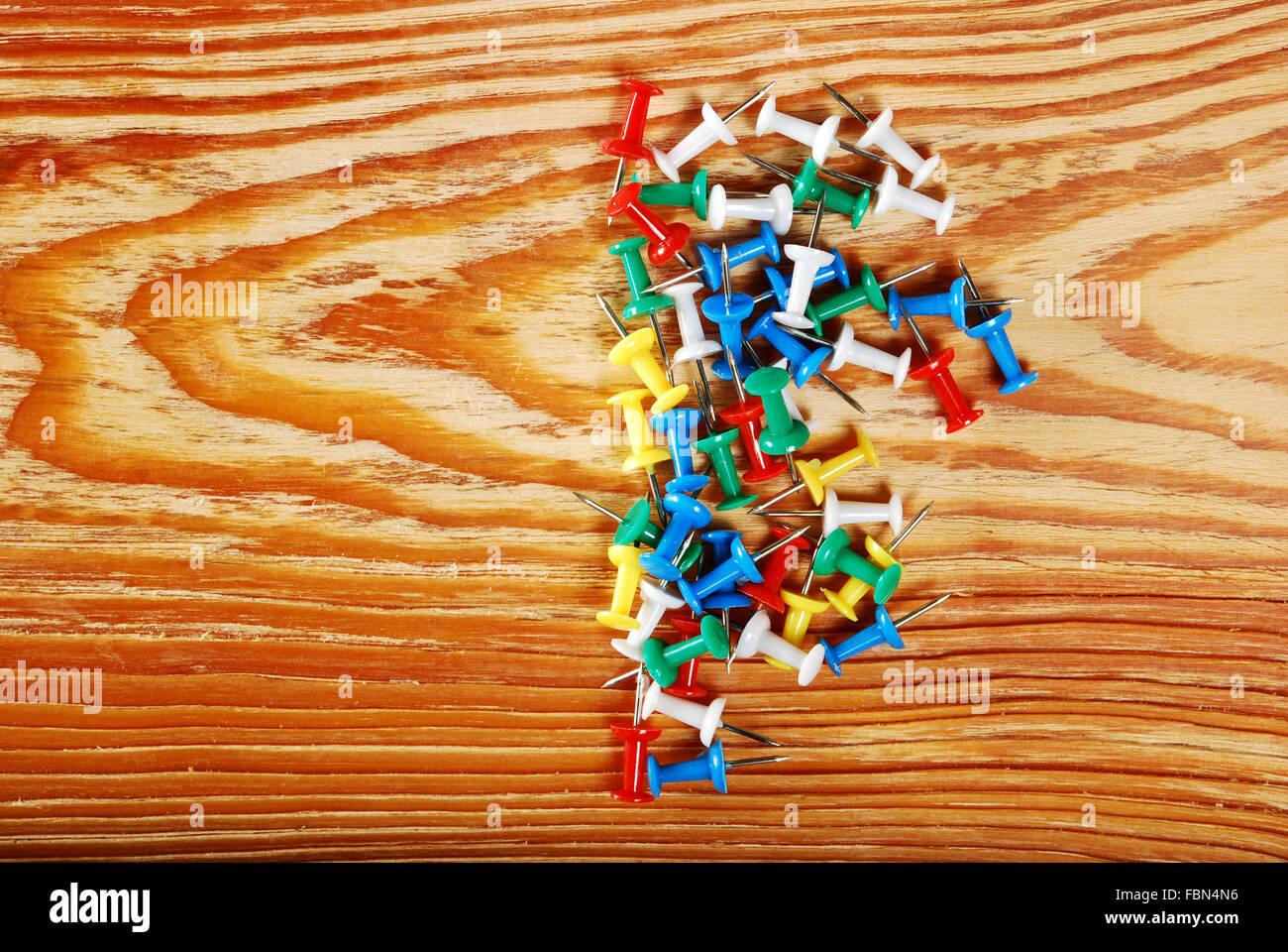 The colored pins on a wooden background Stock Photo - Alamy
