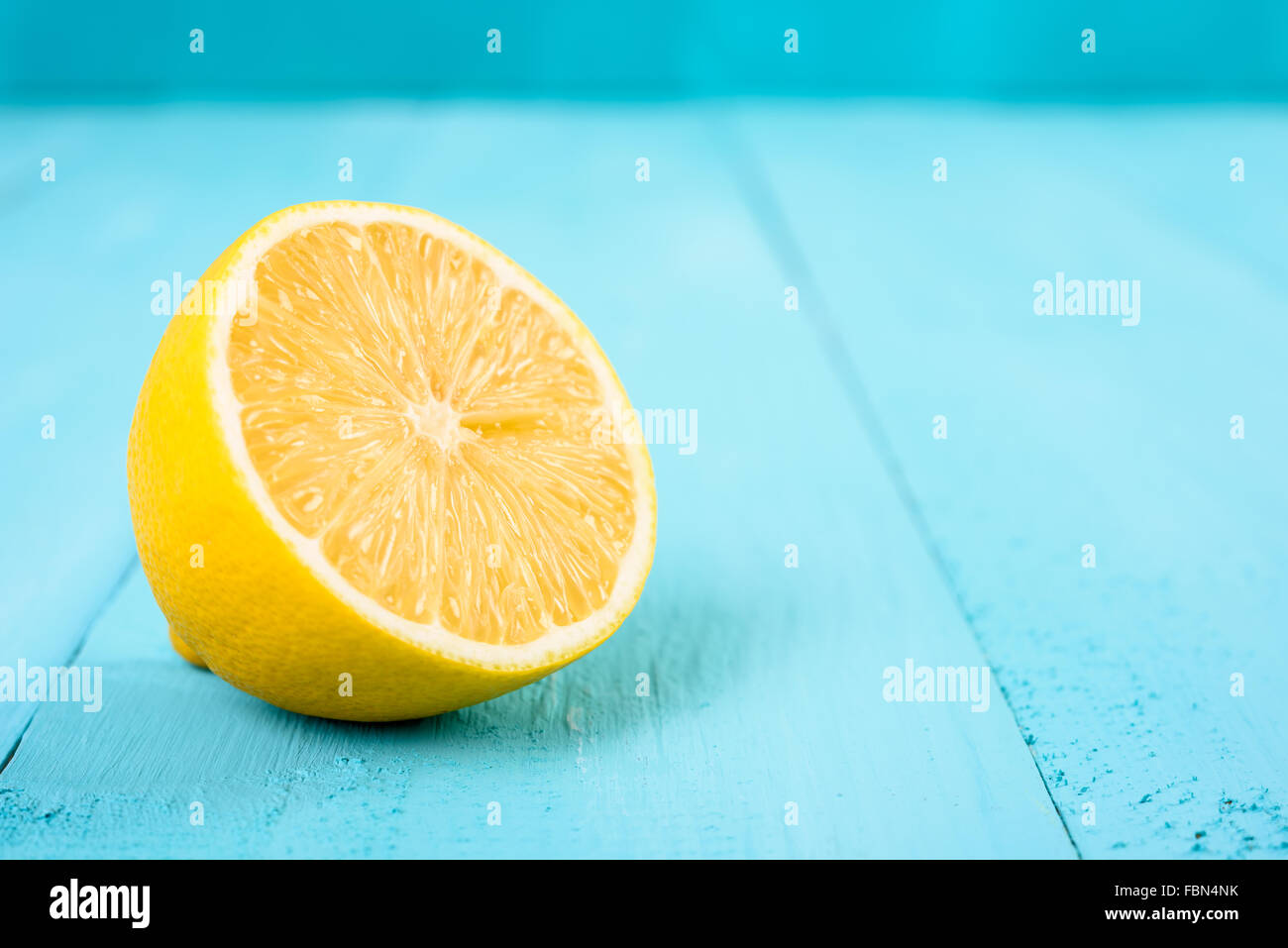 Fresh Yellow Lemon Slice On Turquoise Wood Table Stock Photo - Alamy