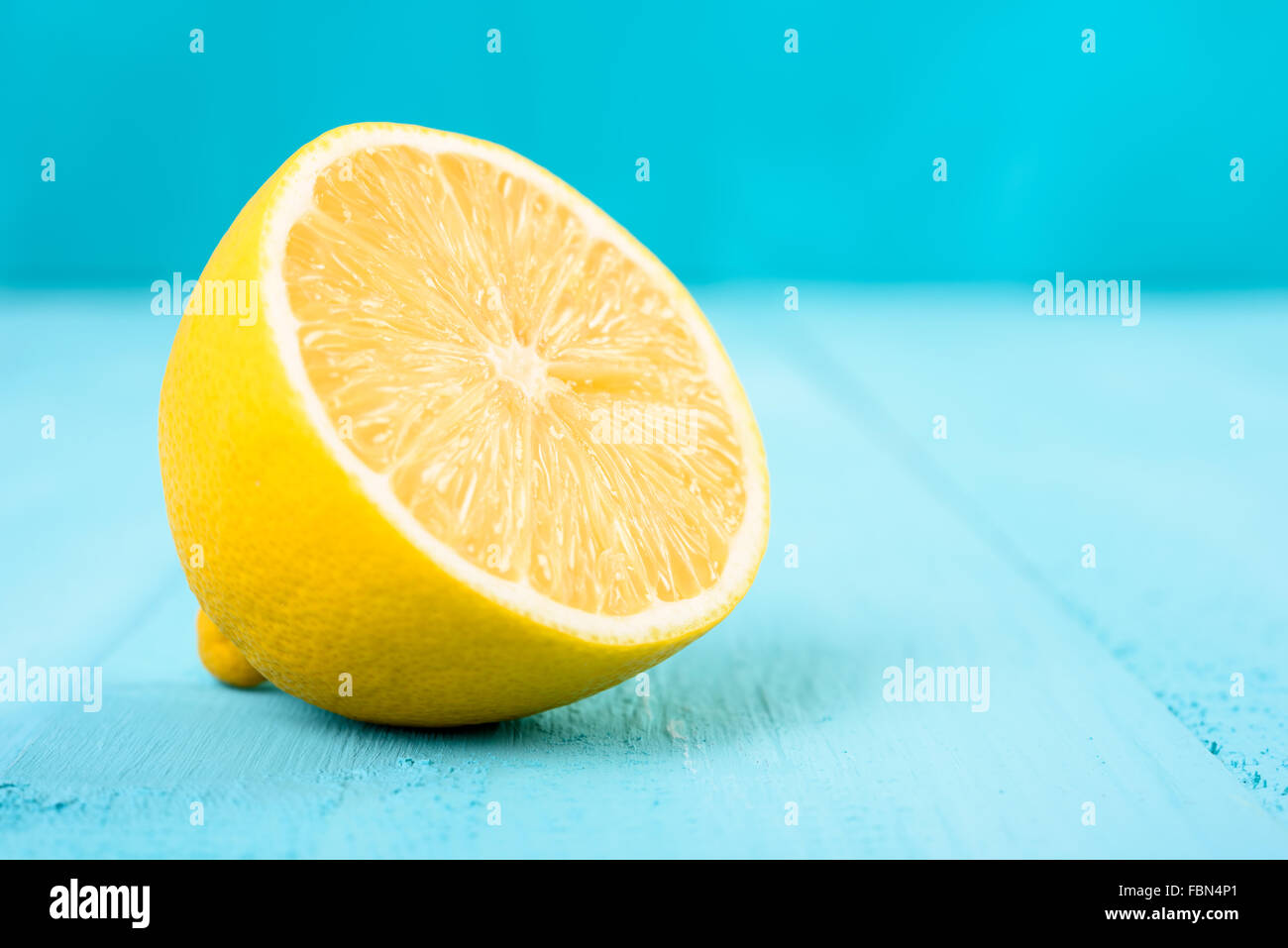 Fresh Yellow Lemon Slice On Turquoise Wood Table Stock Photo - Alamy